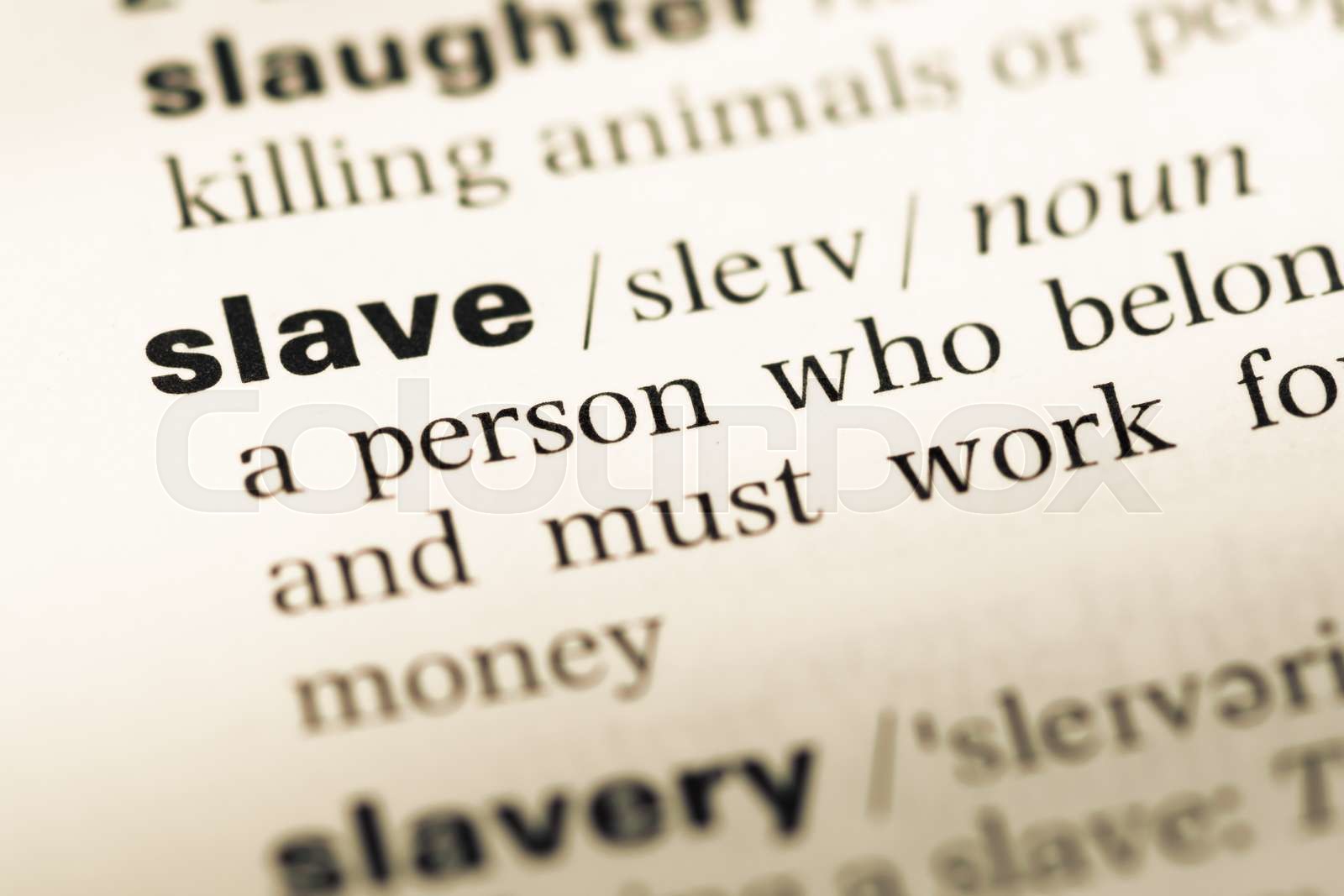 Close up of old English dictionary page with word slave. | Stock image ...