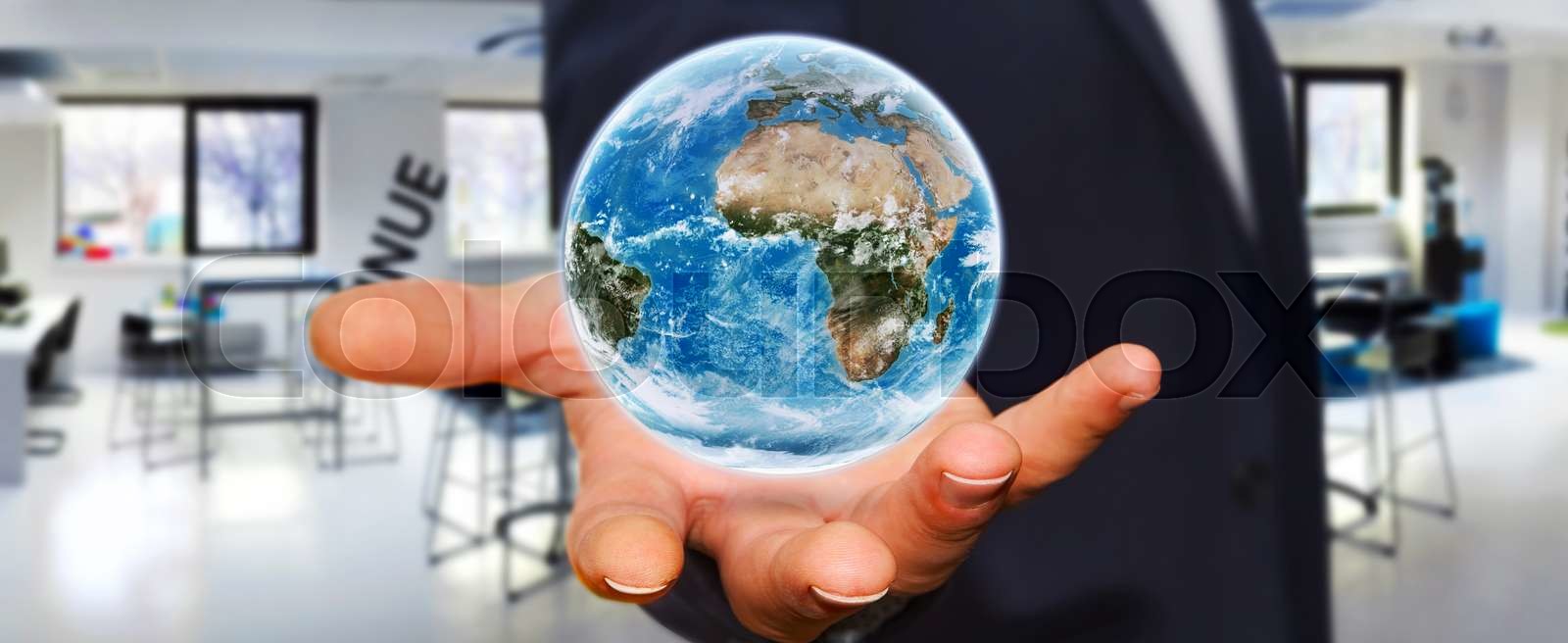 Man holding the planet earth in his hand | Stock image | Colourbox