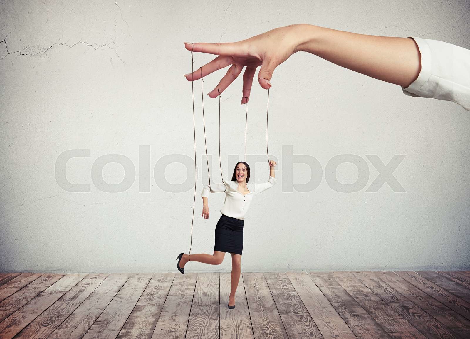 Woman looks like a puppet on strings | Stock image | Colourbox