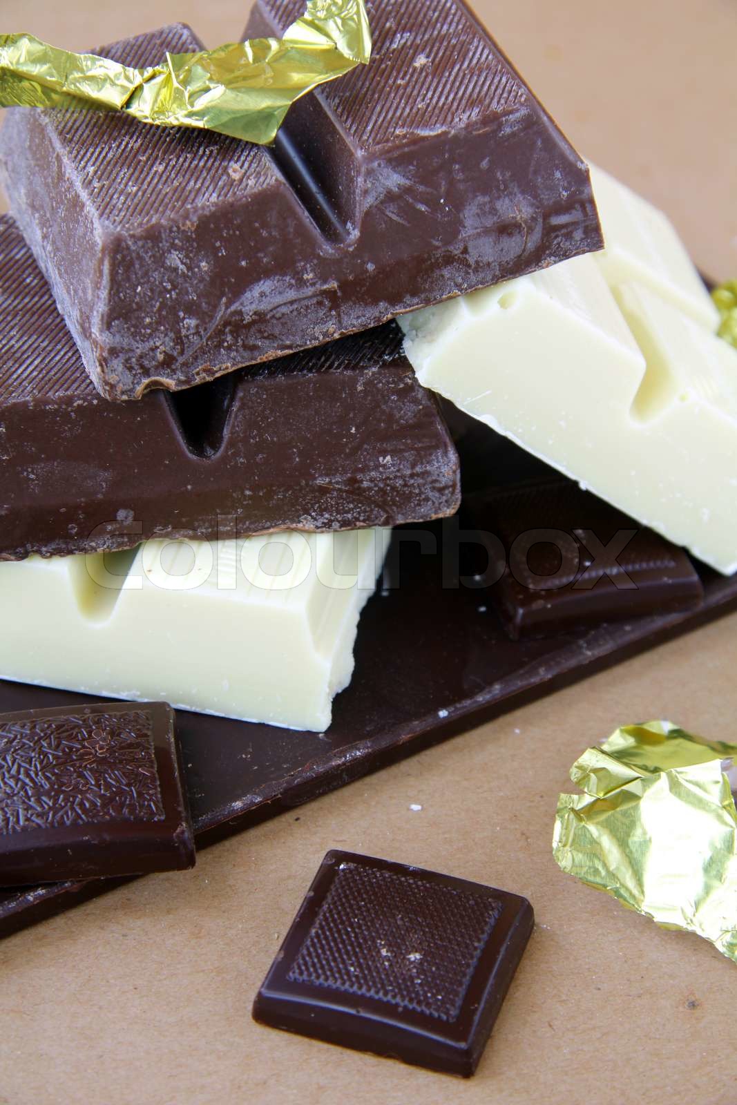 Large pieces of white and dark chocolate on each other | Stock image ...