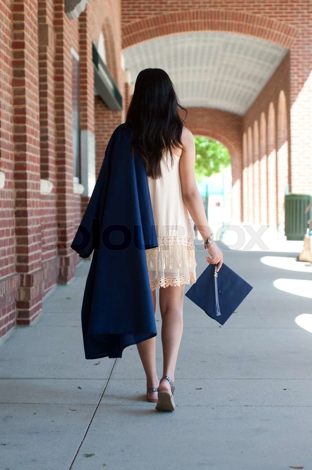 High school Graduate girl walking | Stock image | Colourbox