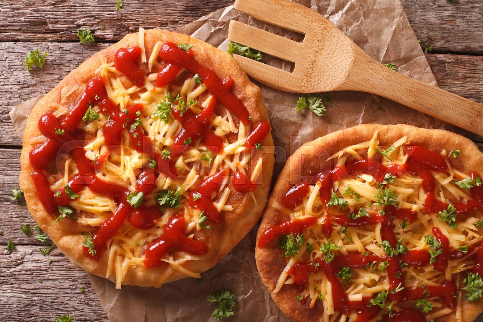 Tasty langos with cheese and ketchup close-up. horizontal top view ...