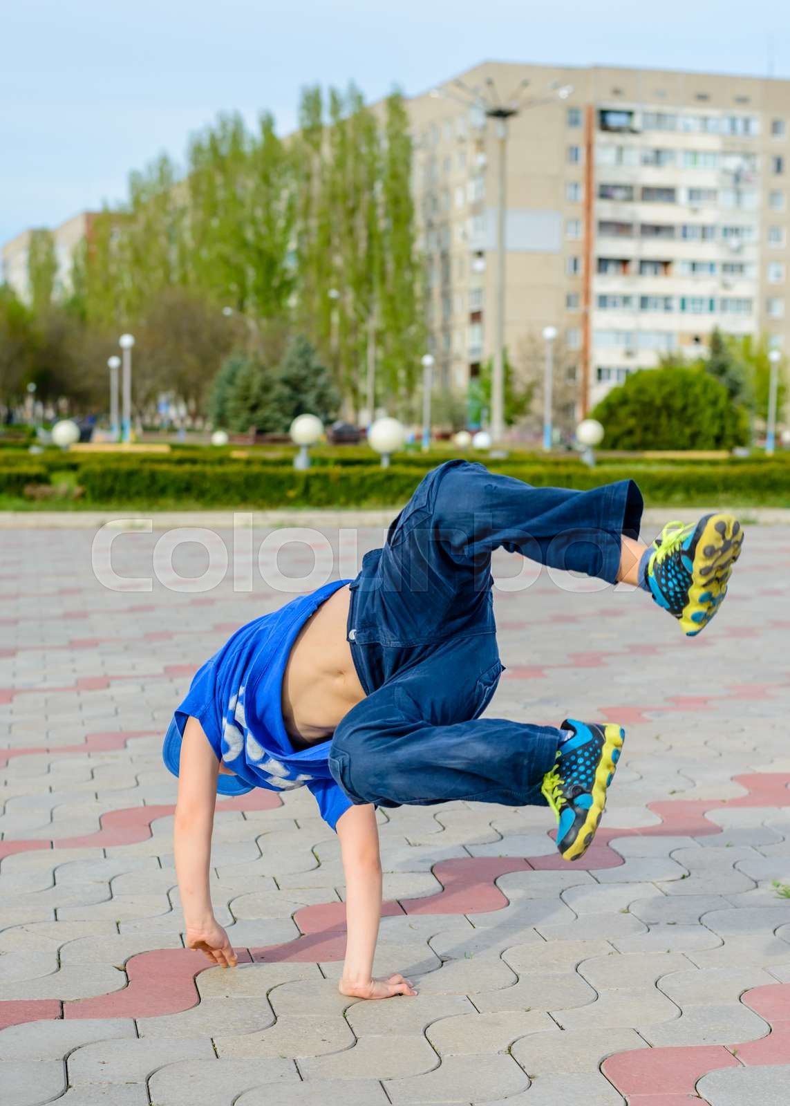 Agile young boy doing cartwheels | Stock image | Colourbox