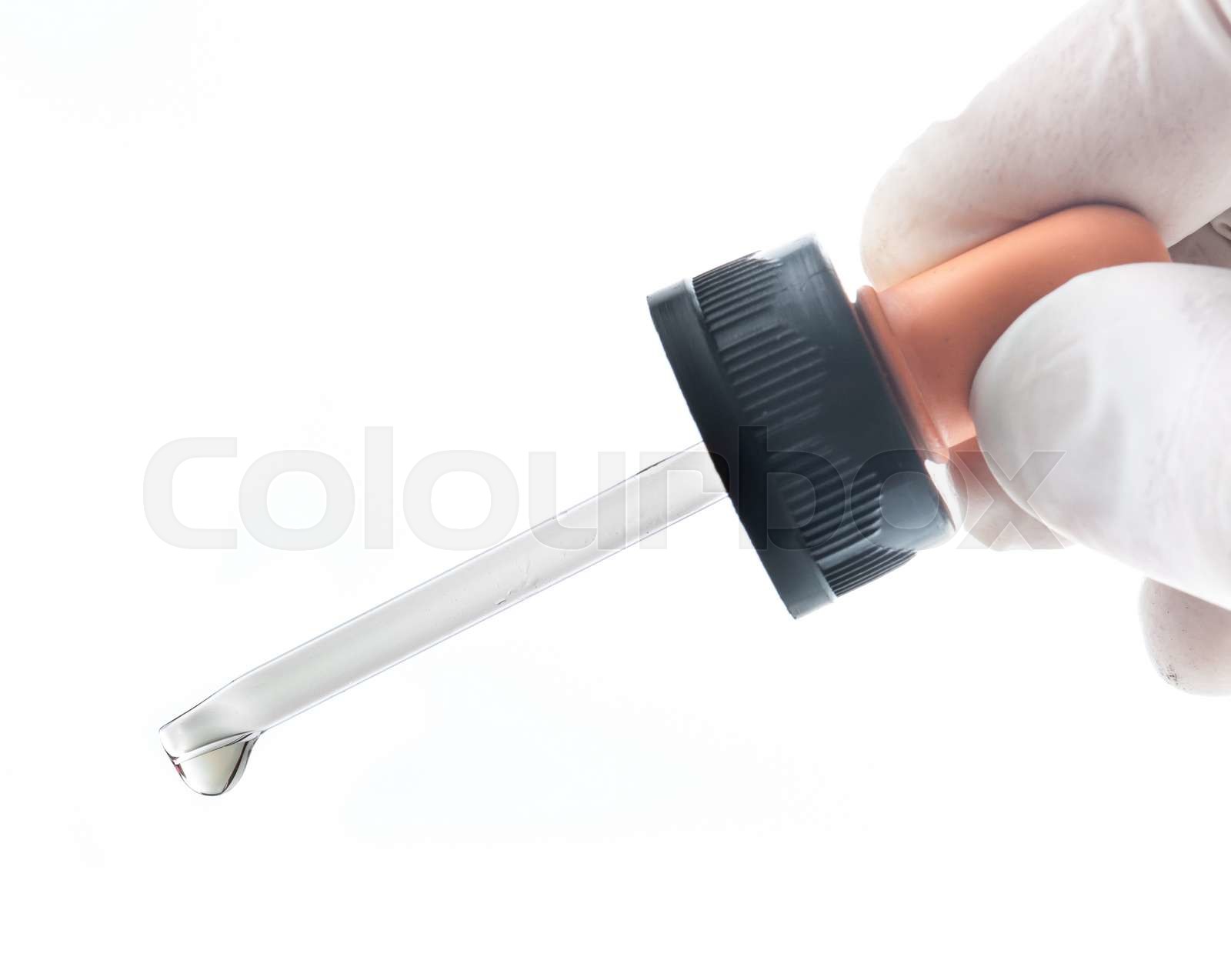 Medicine dropper in hand with dropping isolated over white. | Stock ...