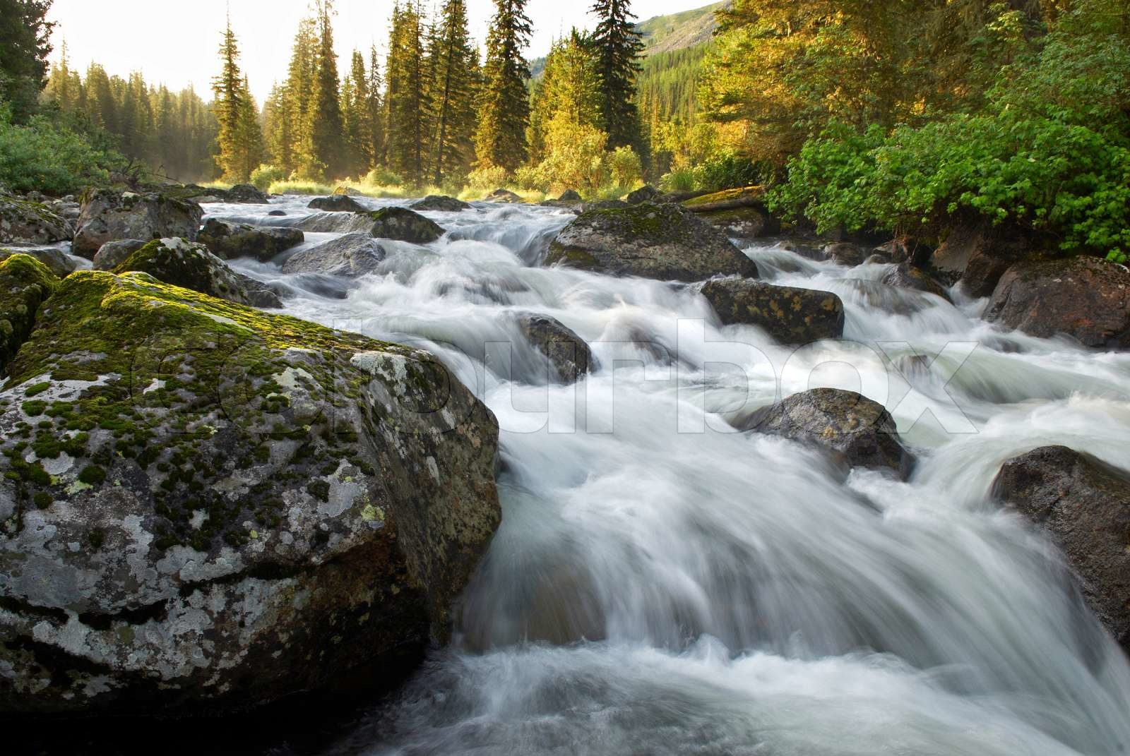 Sunrise and mountain flowing stream | Stock image | Colourbox