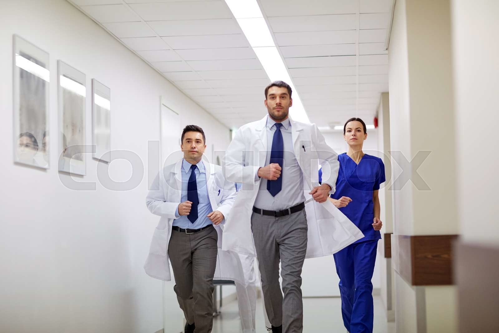 group of medics walking along hospital | Stock image | Colourbox