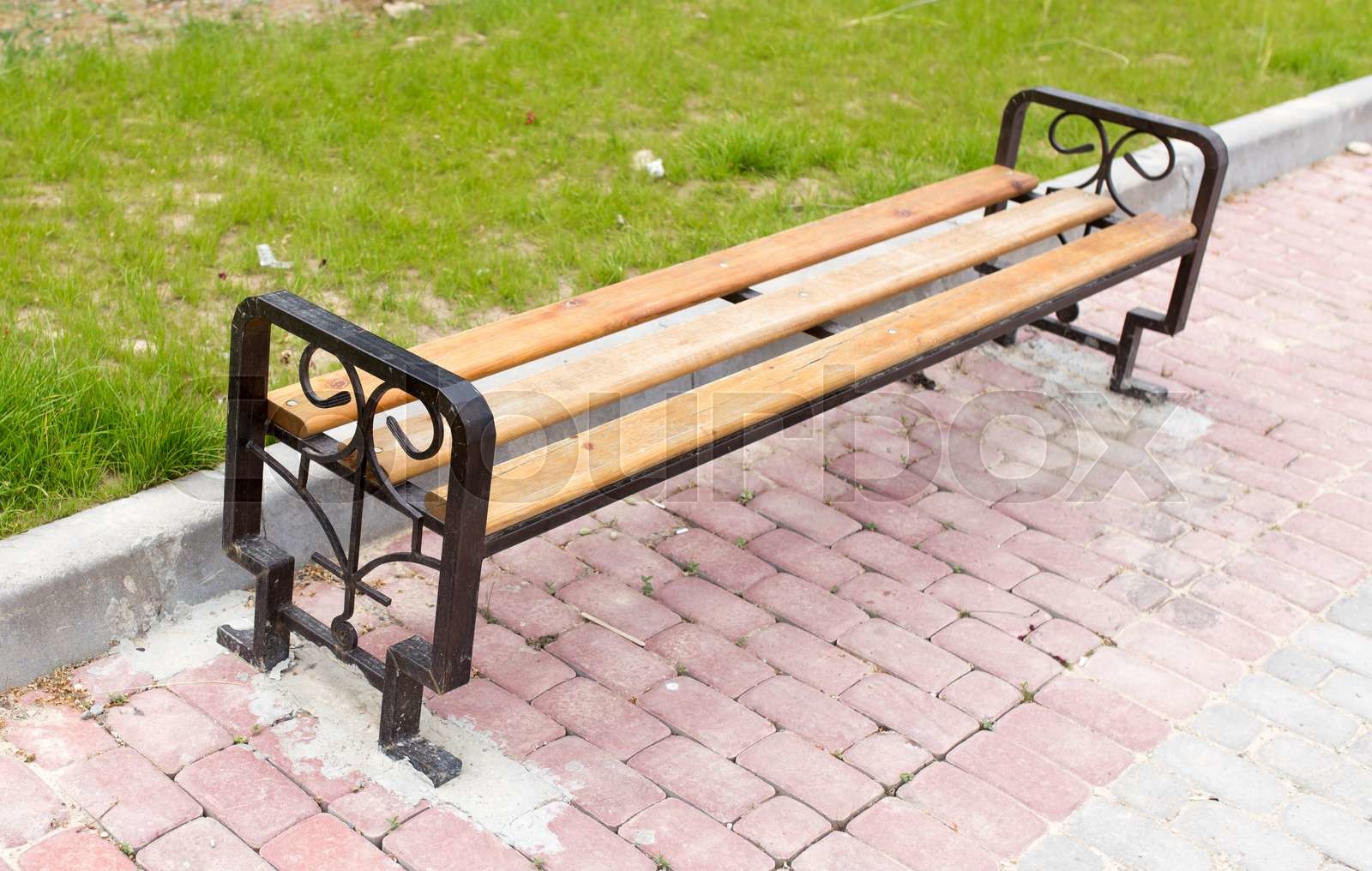 bench on the pavement in the park | Stock image | Colourbox