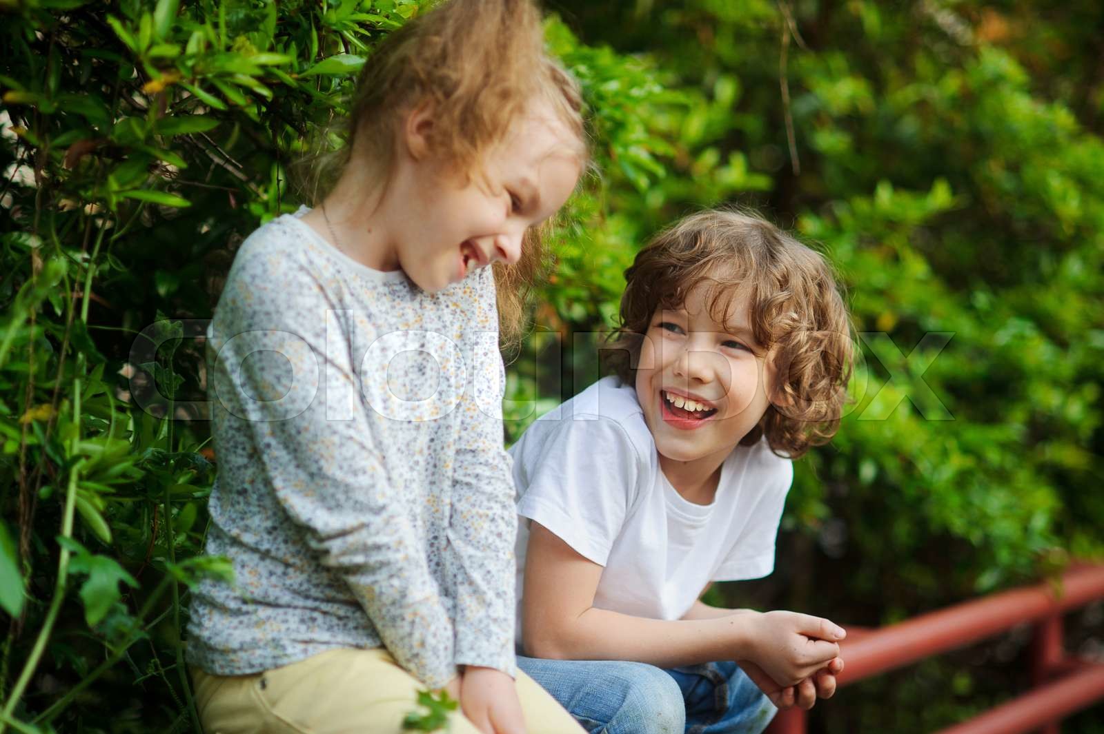 Two kids are sitting and smiling | Stock image | Colourbox