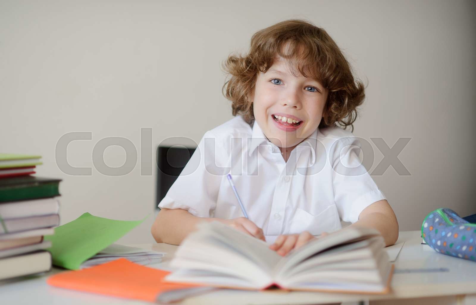 Elementary school student with homework | Stock image | Colourbox
