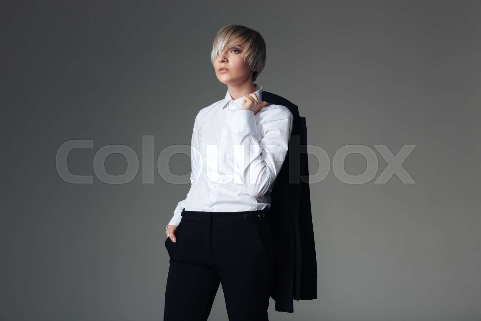 Stylish woman holding jacket on the shoulders | Stock image | Colourbox