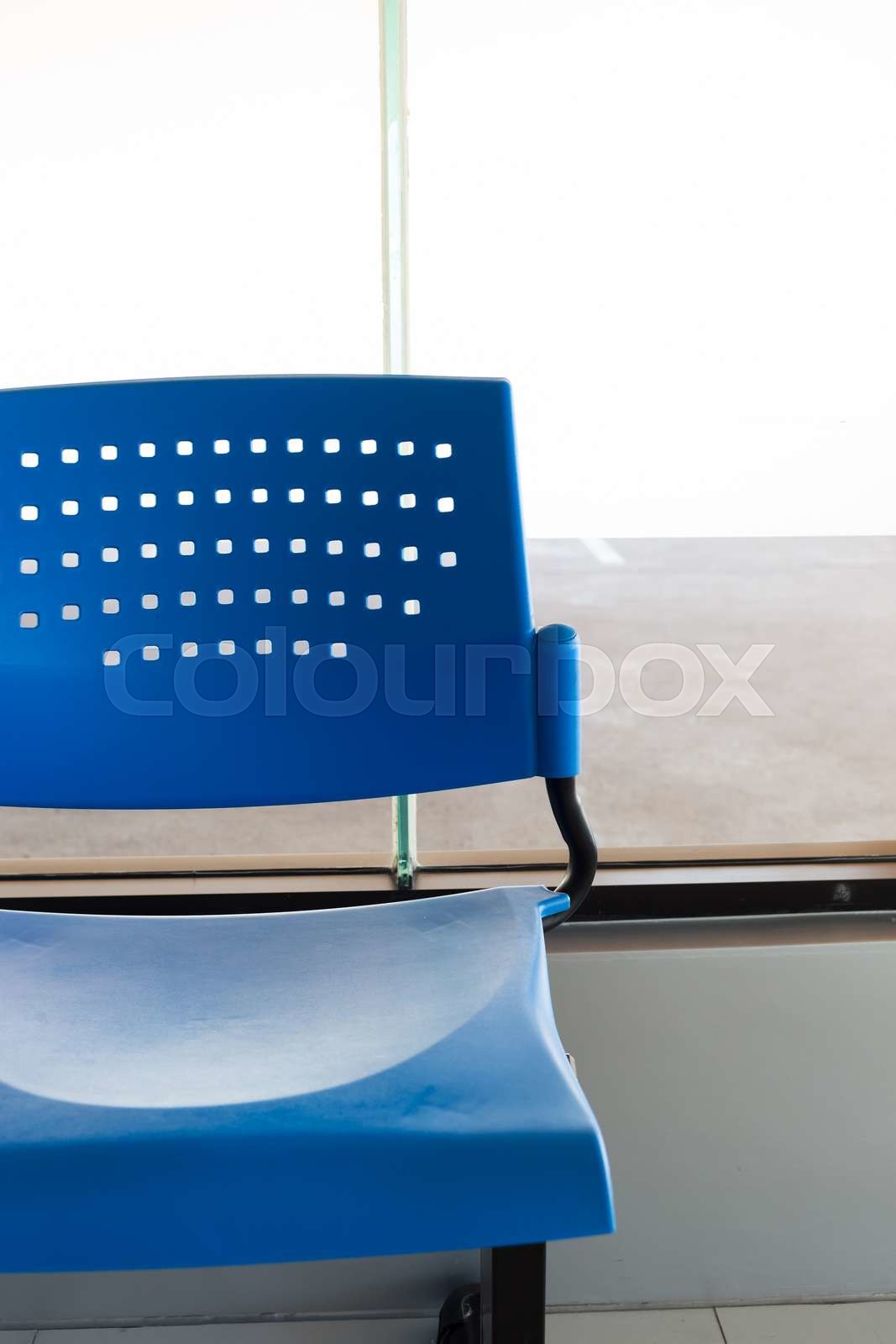 customer waiting area with rows of blue seats in office | Stock image ...