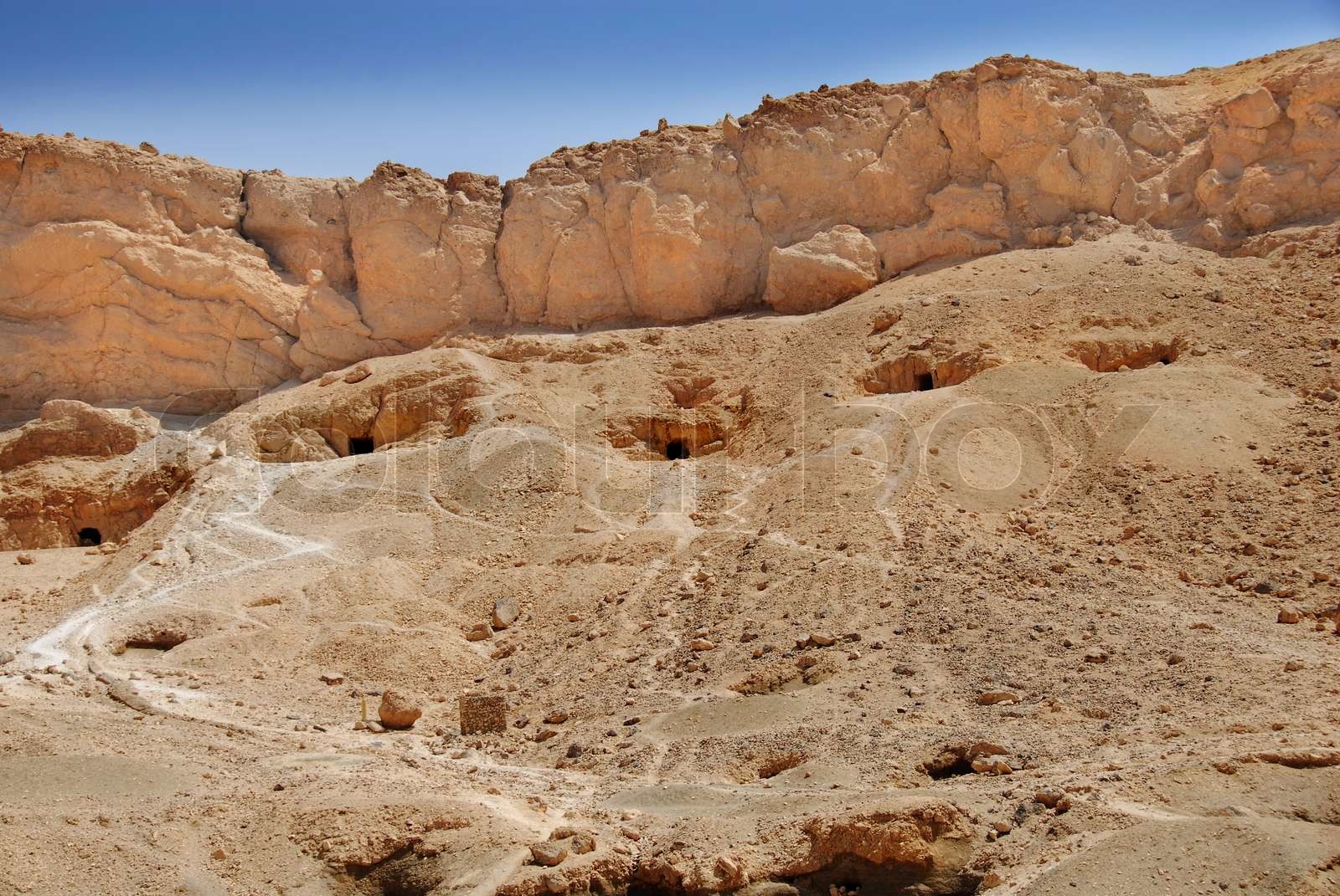 tomb entrances on yellow limestone hill in Luxor, Egypt | Stock image ...