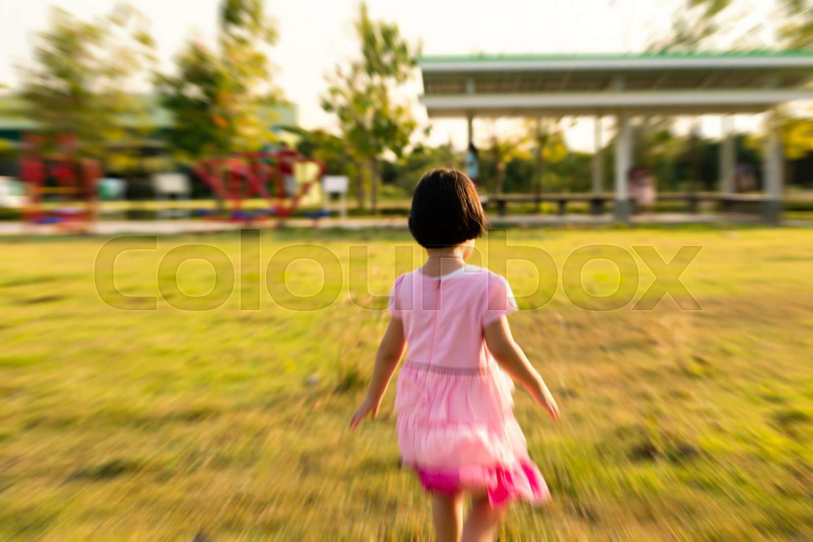 Little girl running in the park outdoor with sunlight. | Stock image ...