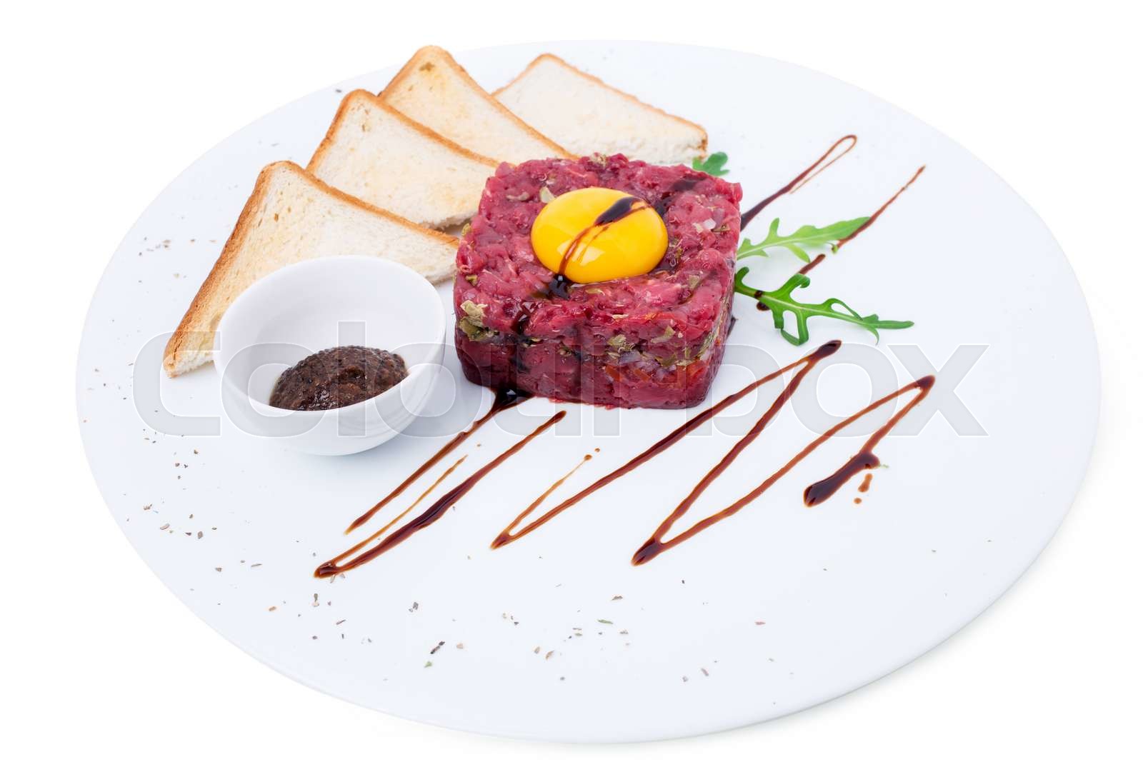 Delicious steak tartare with egg yolk. | Stock image | Colourbox