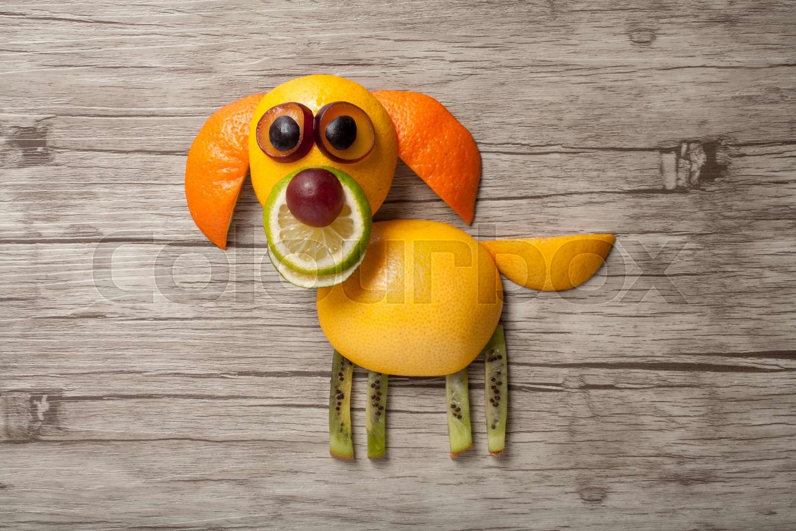 Dog made of fruits on wooden desk | Stock image | Colourbox