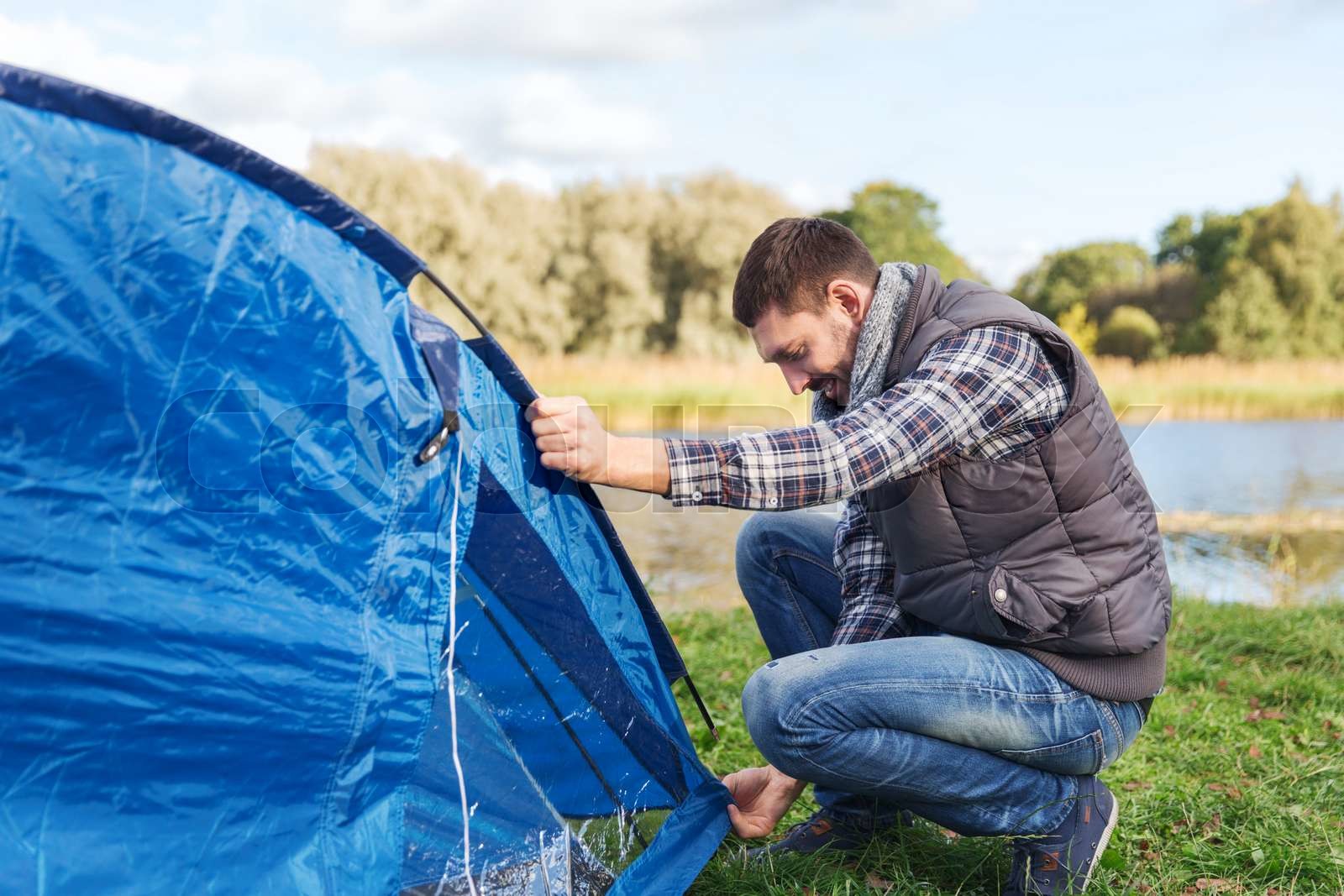happy man setting up tent outdoors | Stock image | Colourbox happy man setting up tent outdoors | Stock image | Colourbox