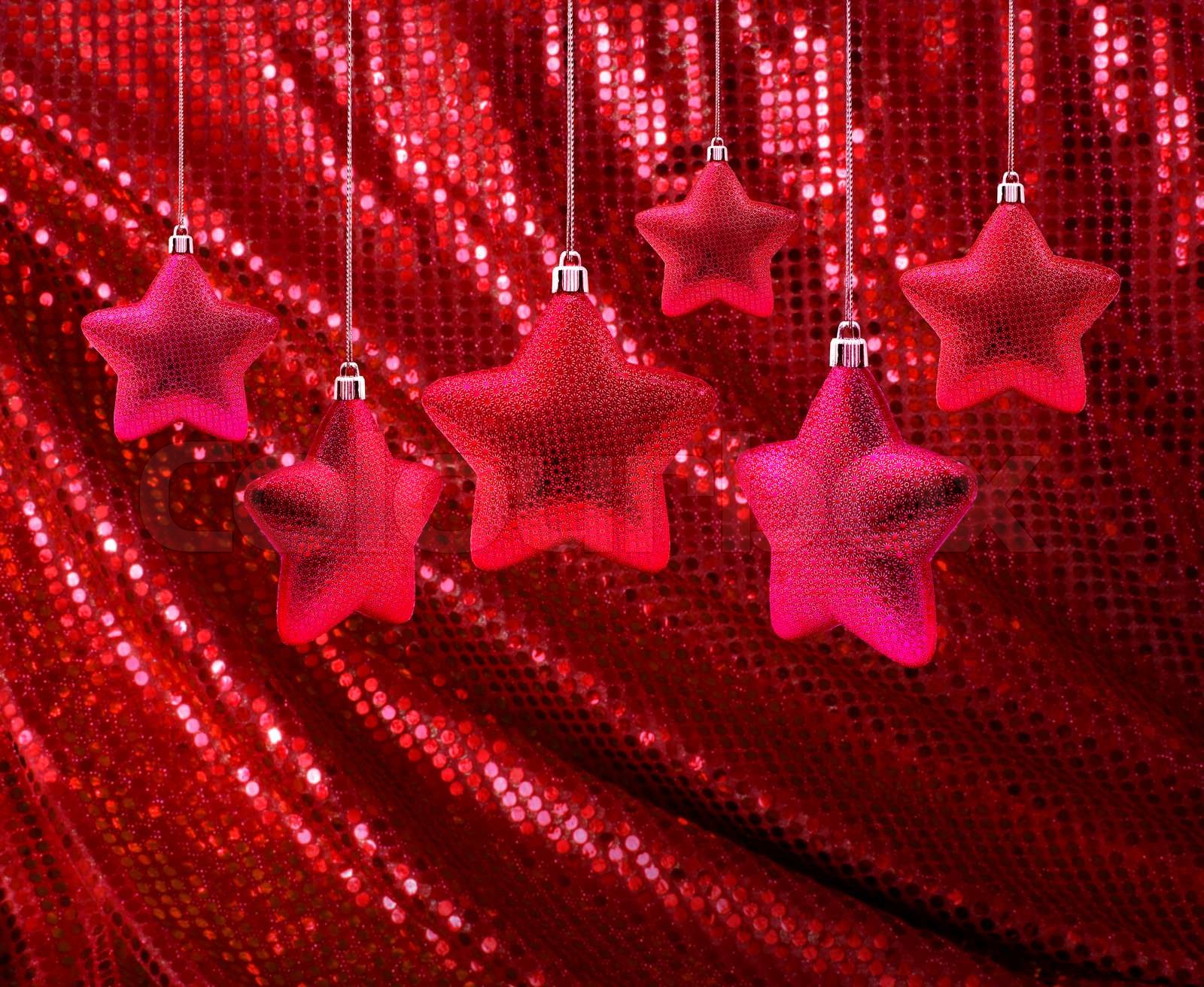 Red Christmas decoration stars hanging on red glitter canvas | Stock ...