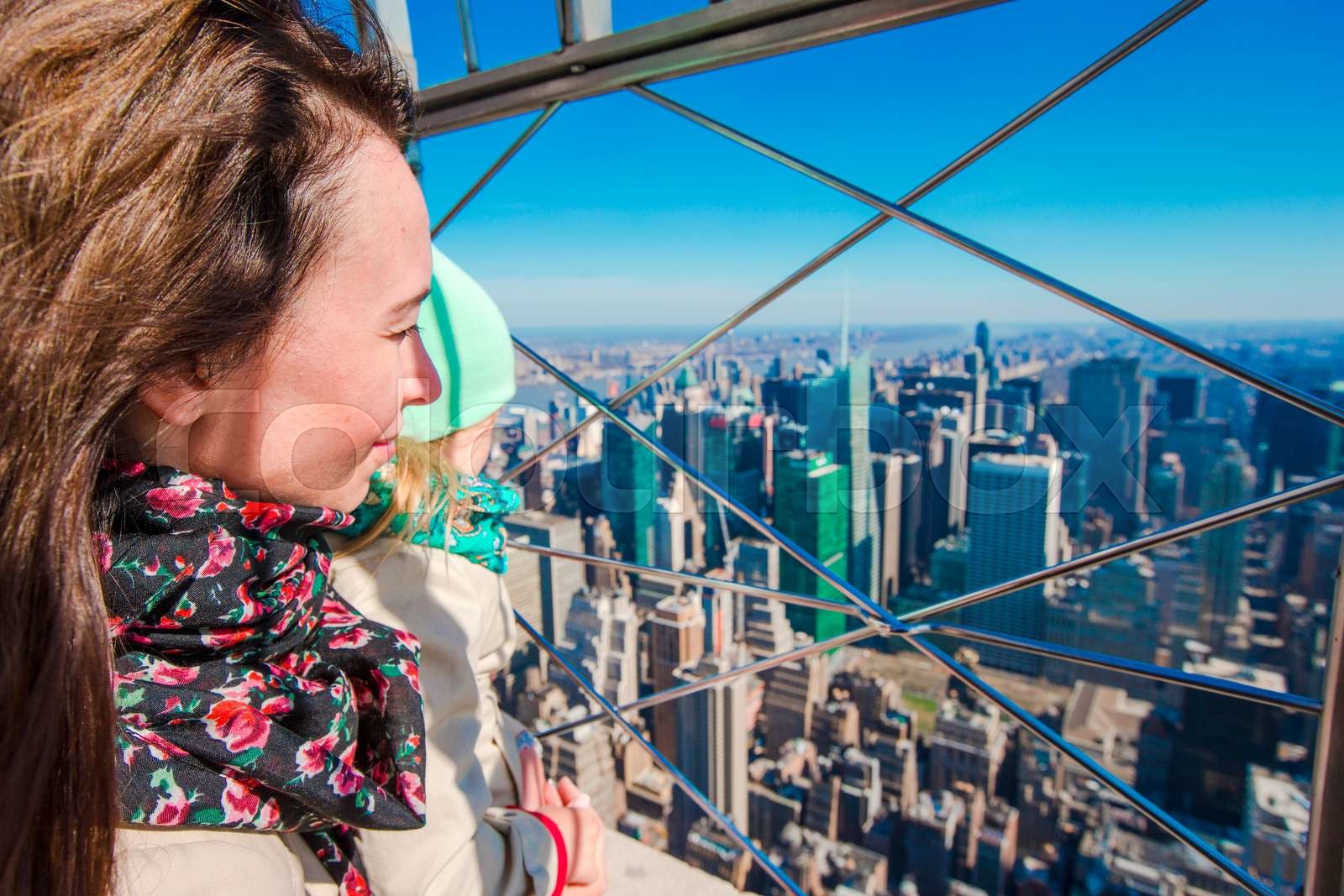 Family enjoy view to New York City from Empire State Building | Stock ...