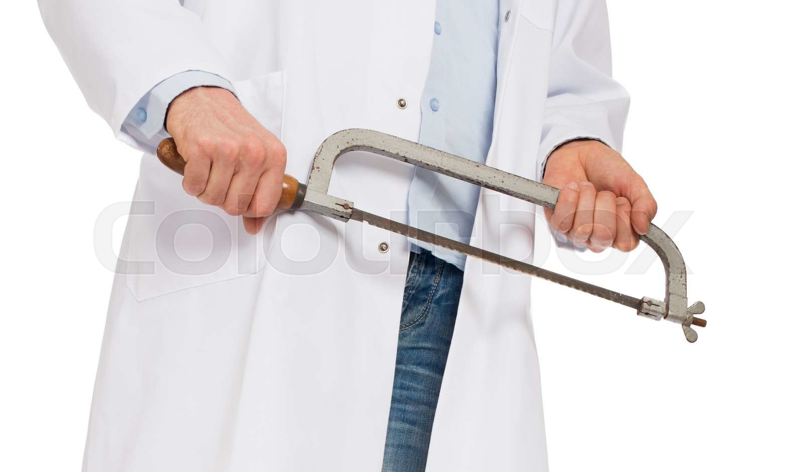 Crazy doctor is holding a big saw in his hands | Stock image | Colourbox