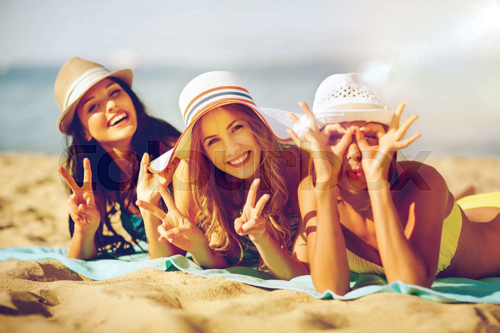 girls sunbathing on the beach | Stock image | Colourbox