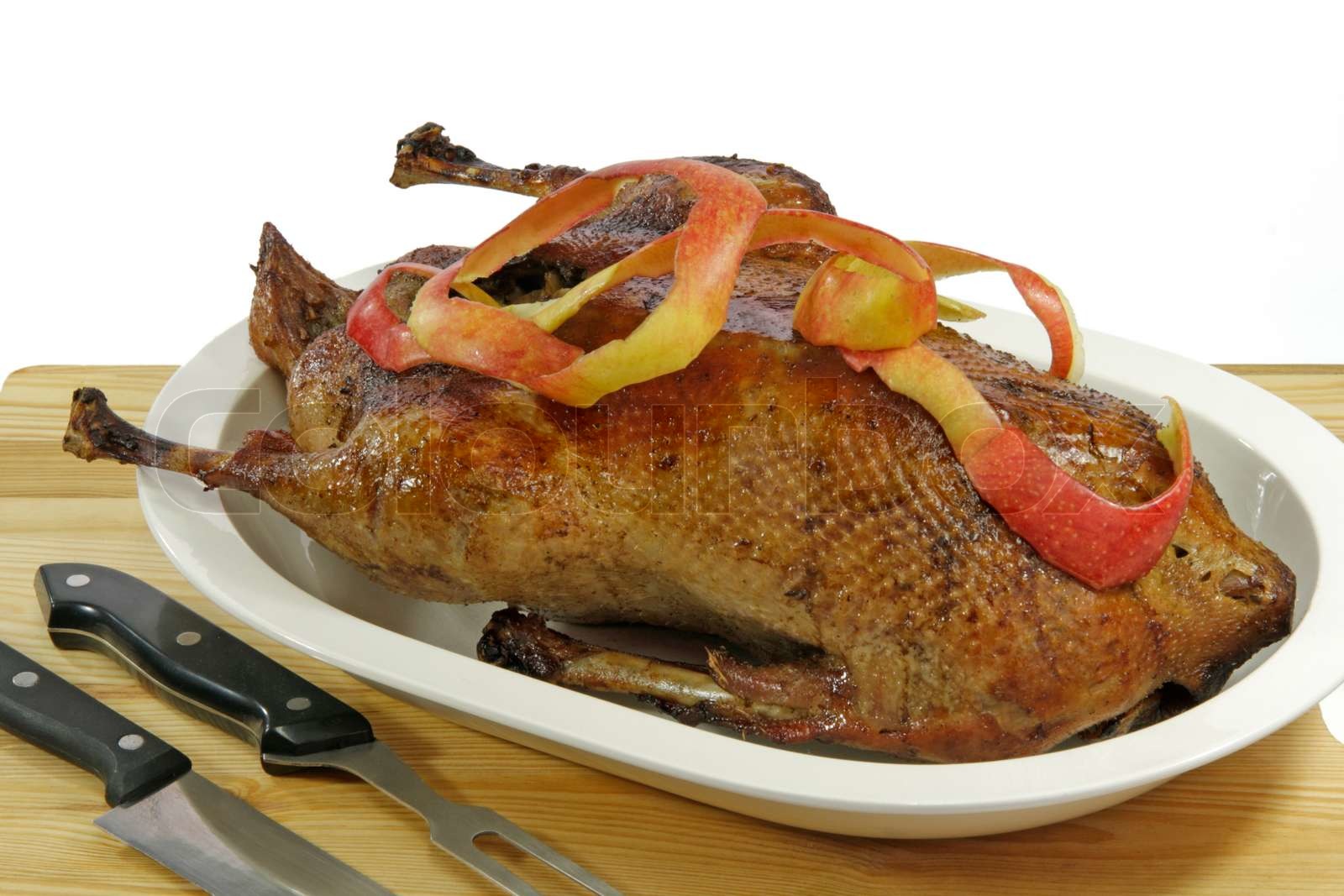 Crunchy roasted goose stuffed with apples on a plate | Stock image ...