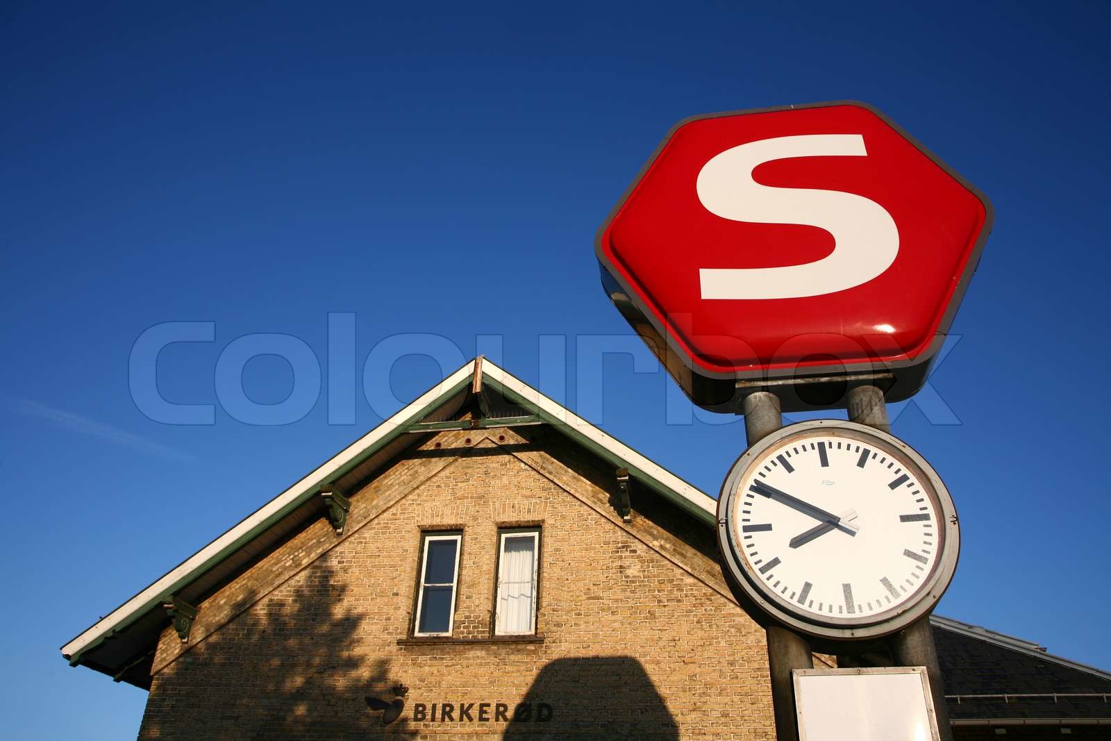 Clock and sign at Birkerød train station | Stock image | Colourbox