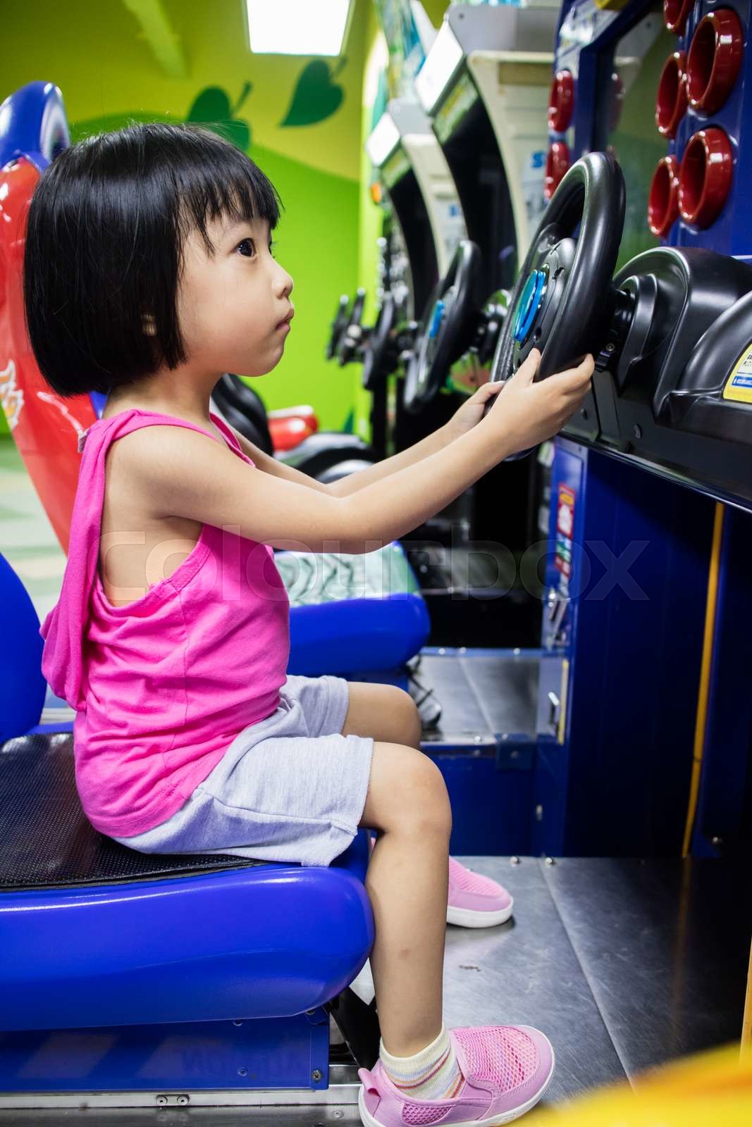 Asian Little Chinese Girl Playing Arcade Game Machine | Stock image ...
