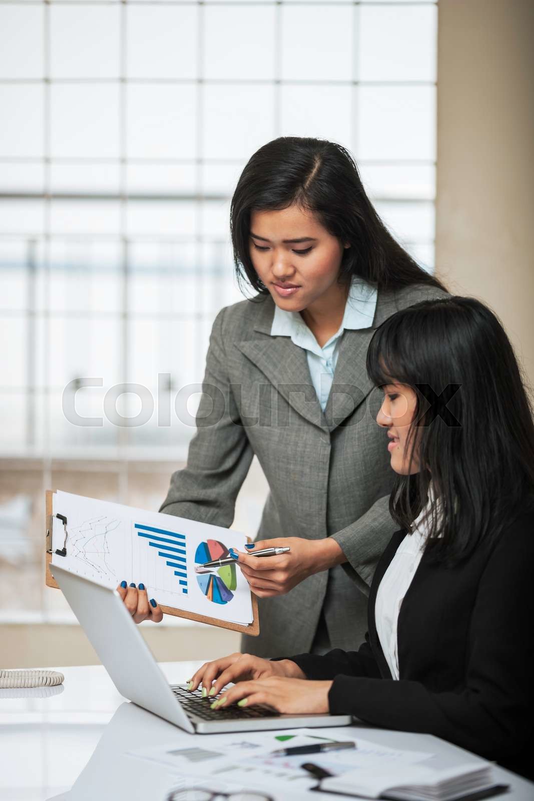 employees showing graphics | Stock image | Colourbox