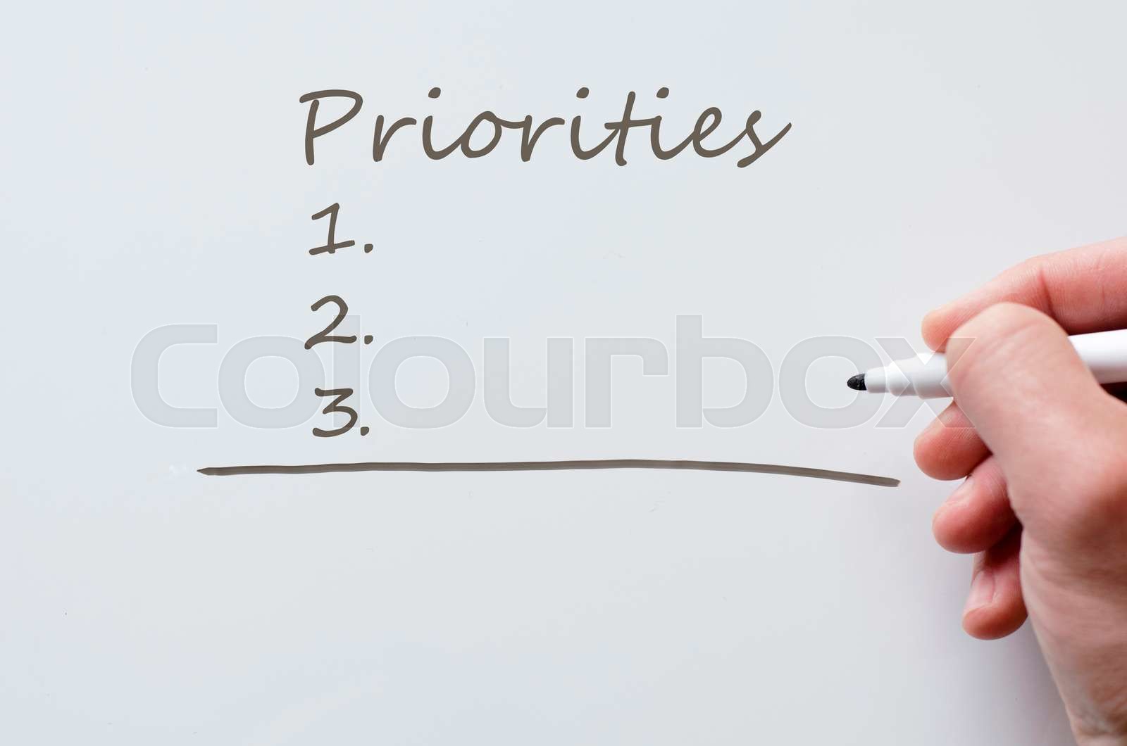 Priorities written on whiteboard | Stock image | Colourbox