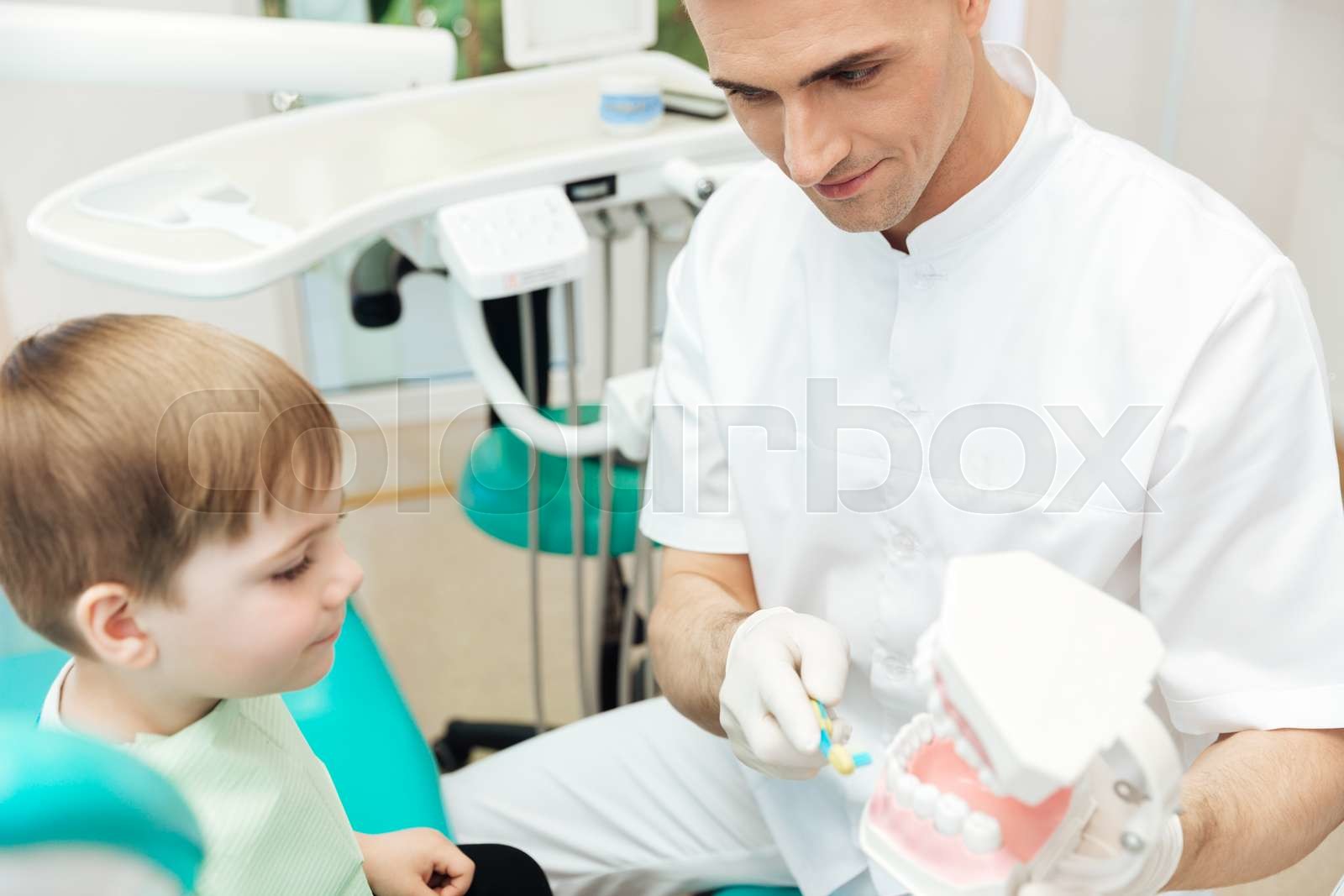 Dentist showing how to brush teeth and use toothbrush | Stock image ...