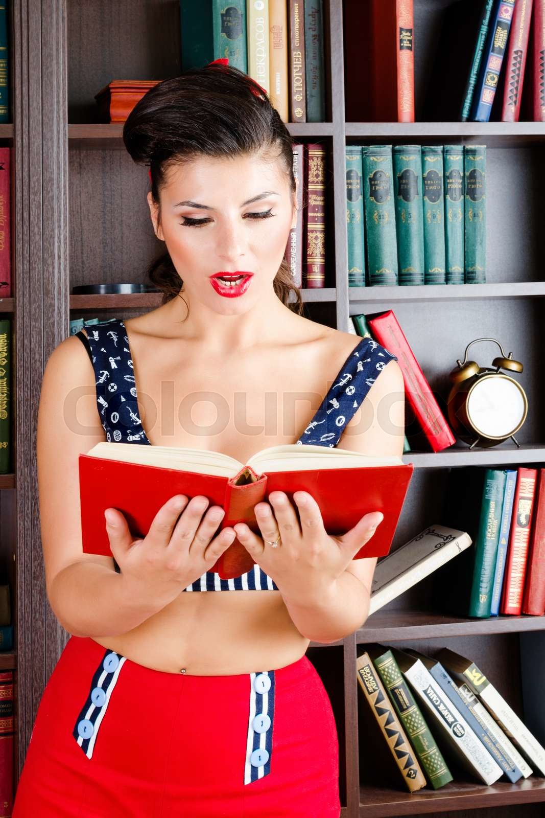 Beautiful young retro pinup woman reading book in the library. | Stock ... Beautiful young retro pinup woman reading book in the library. | Stock ...