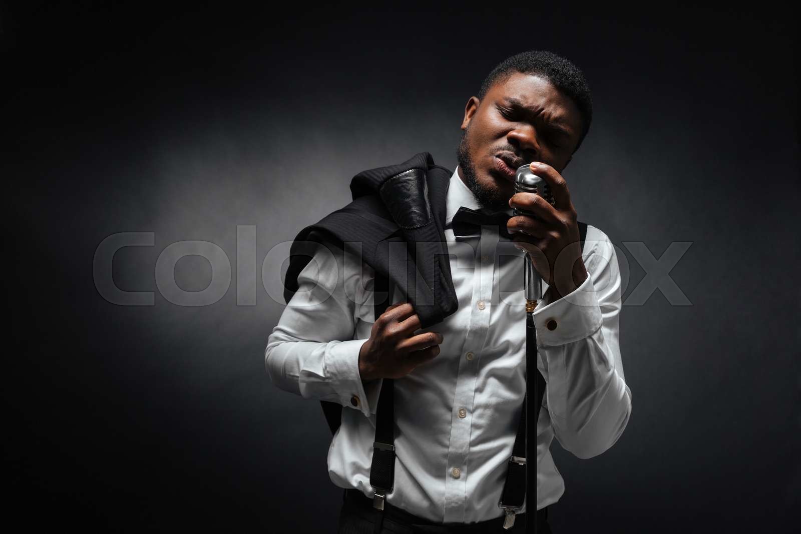 Man singing into vintage microphone | Stock image | Colourbox