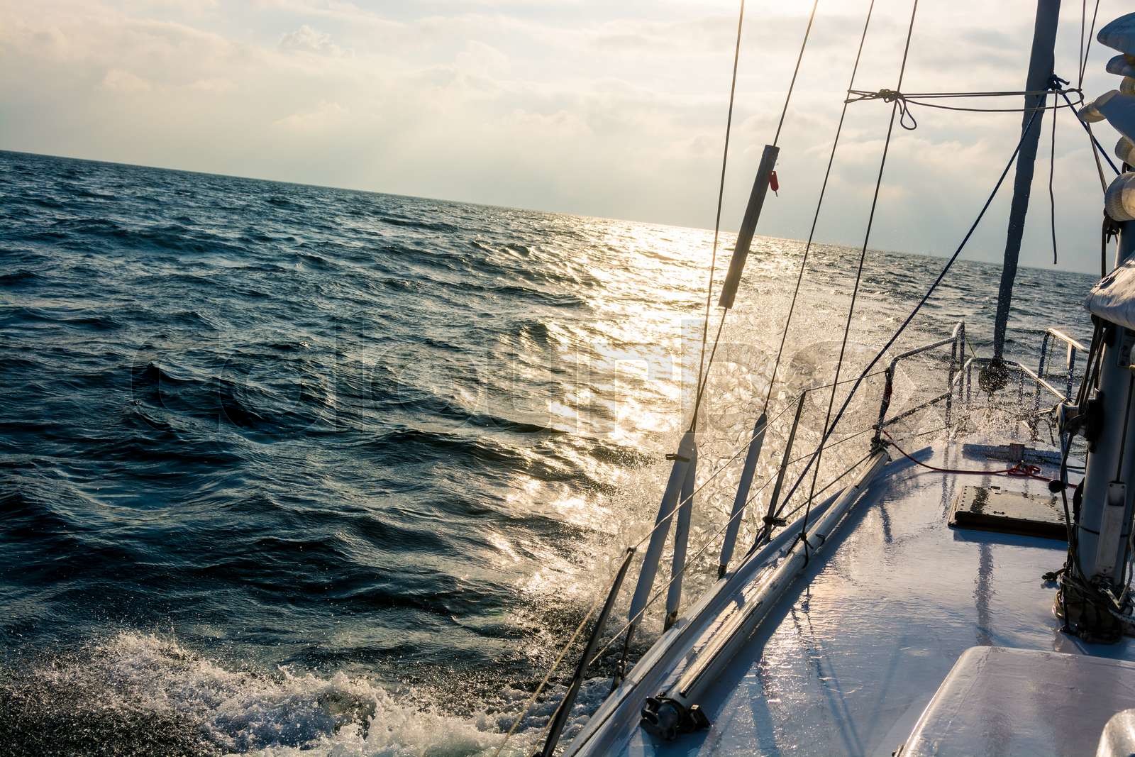 Sailboat creating splash on the open sea | Stock image | Colourbox