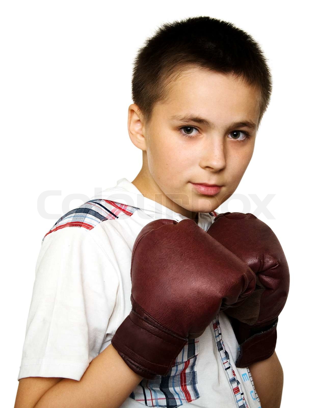 Young boy wearing brown boxing gloves | Stock image | Colourbox