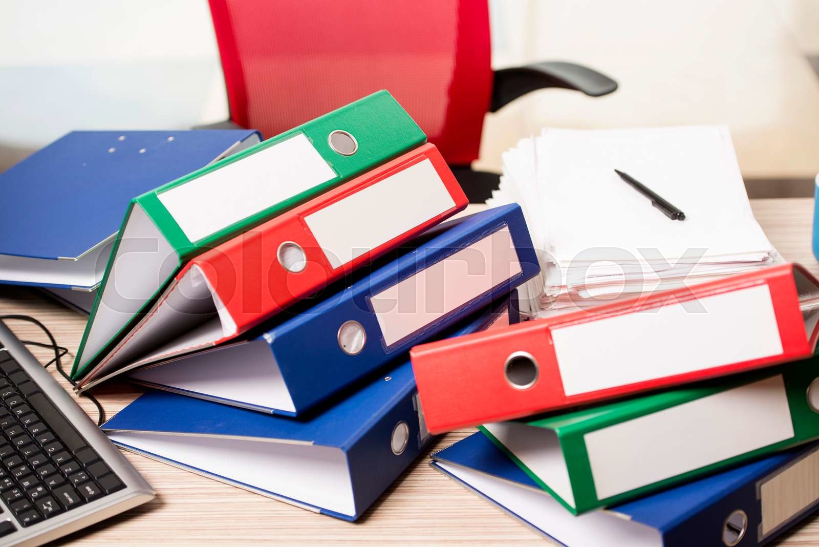 Stacks of office binders on desk | Stock image | Colourbox
