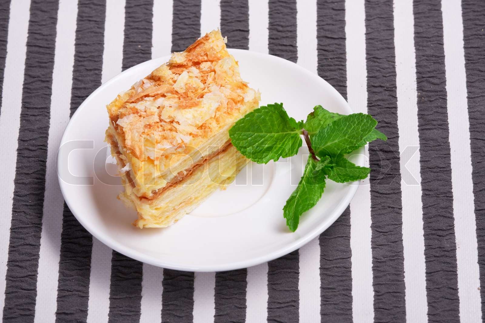 Napoleon kage med frisk mynte på hvid plade | Stock foto | Colourbox