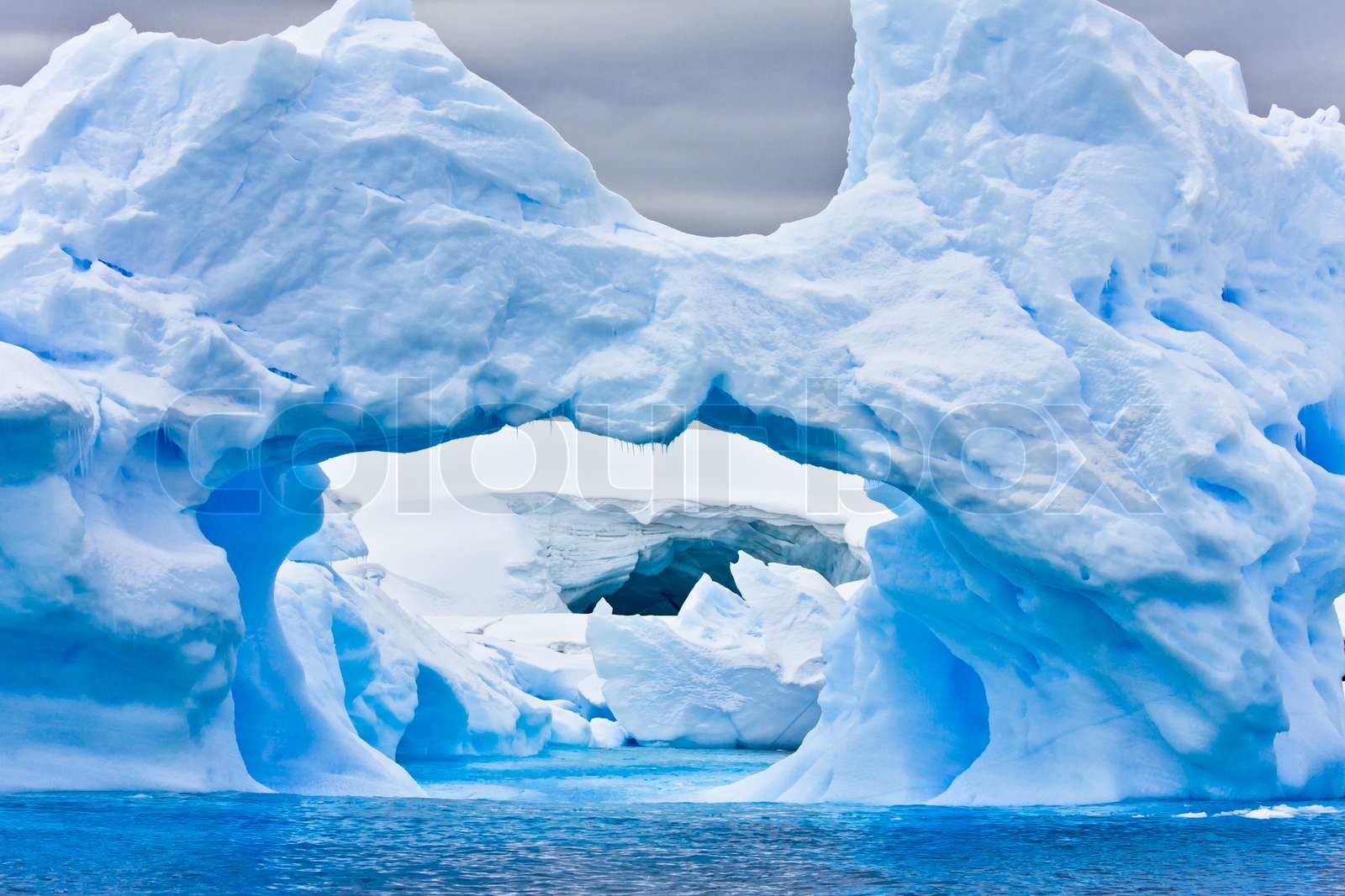Large Arctic iceberg with a cavity inside | Stock image | Colourbox
