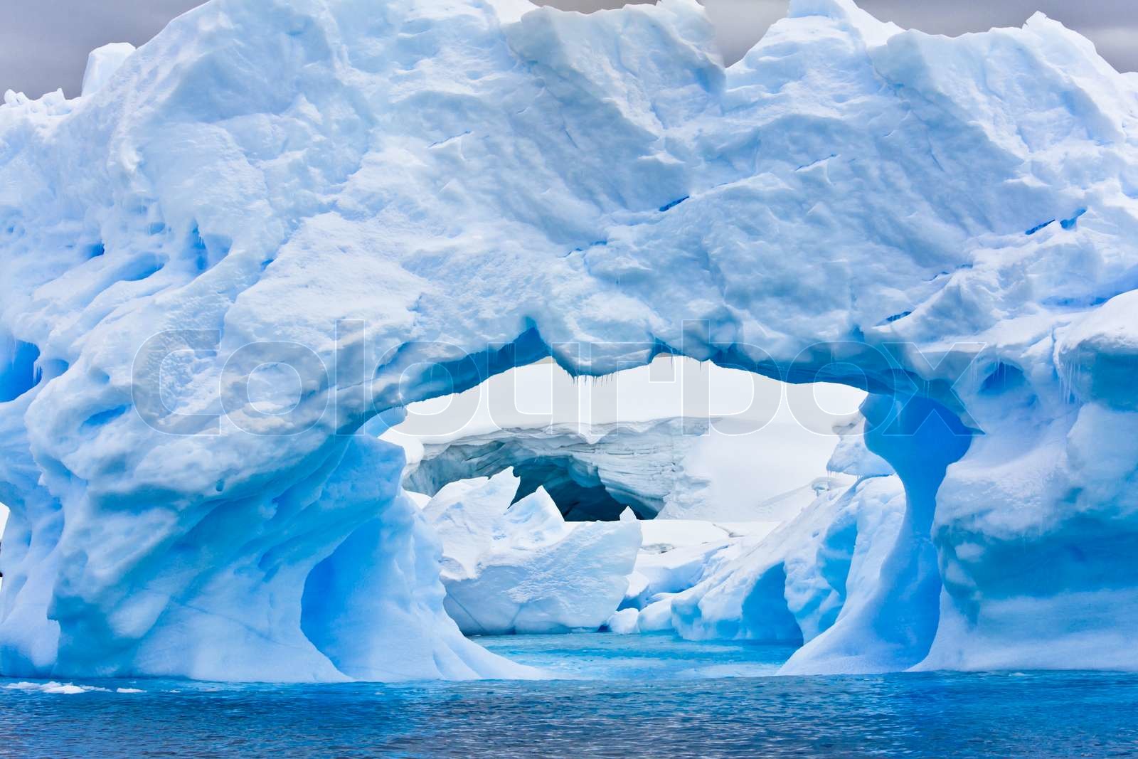 Large Arctic iceberg with a cavity inside | Stock image | Colourbox