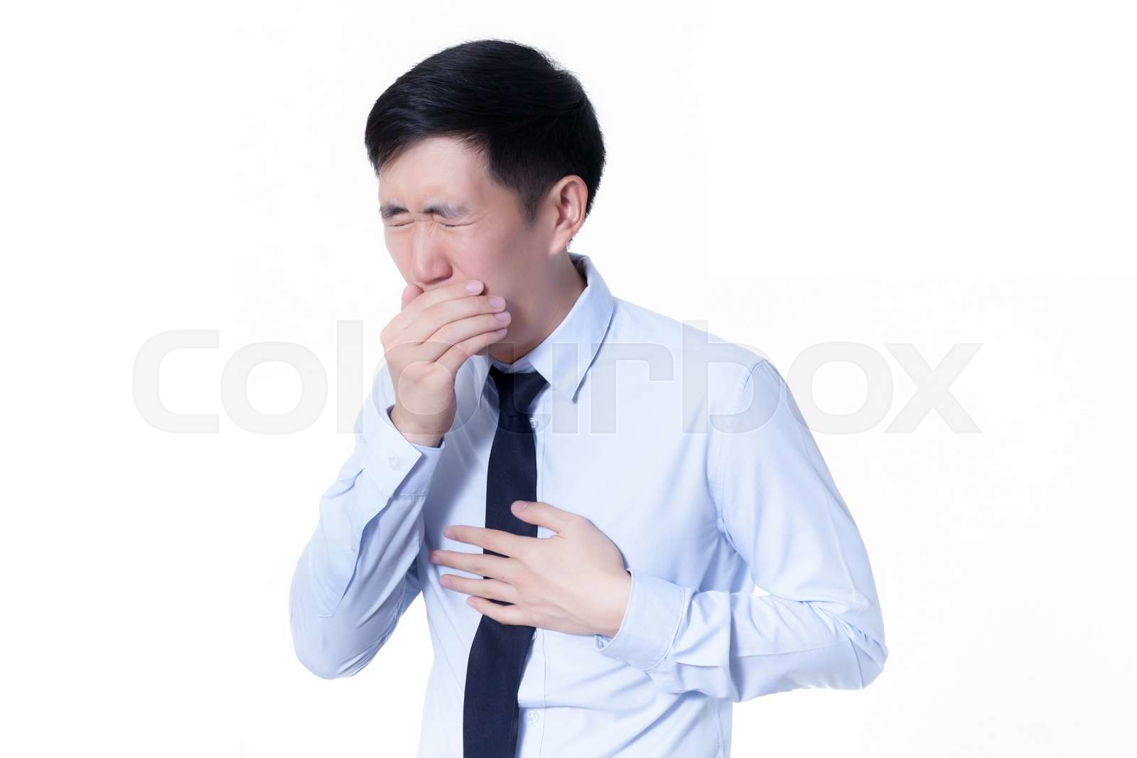 Asian businessman suffering from a bad cough | Stock image | Colourbox