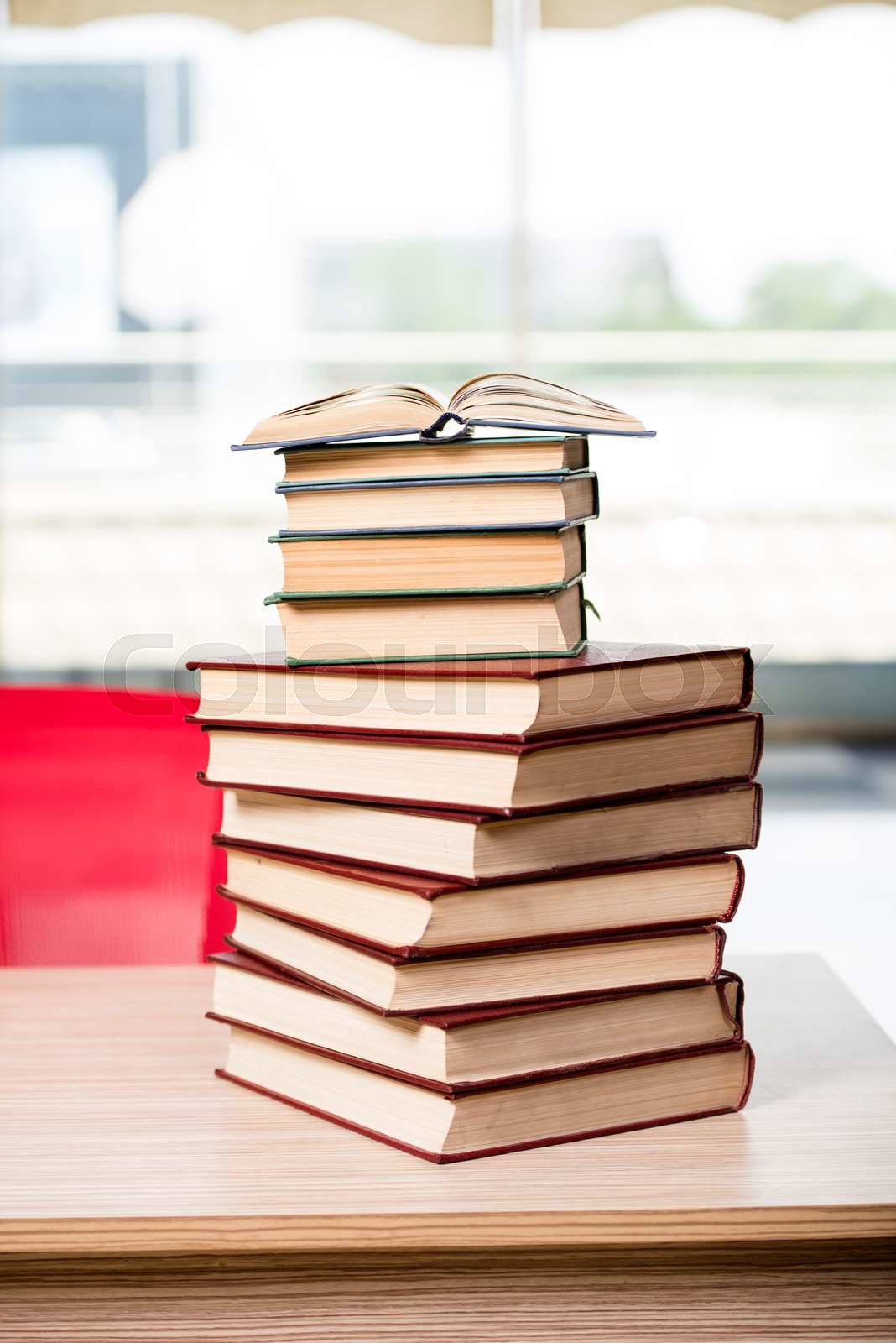 Stack of books arranged the office desk | Stock image | Colourbox