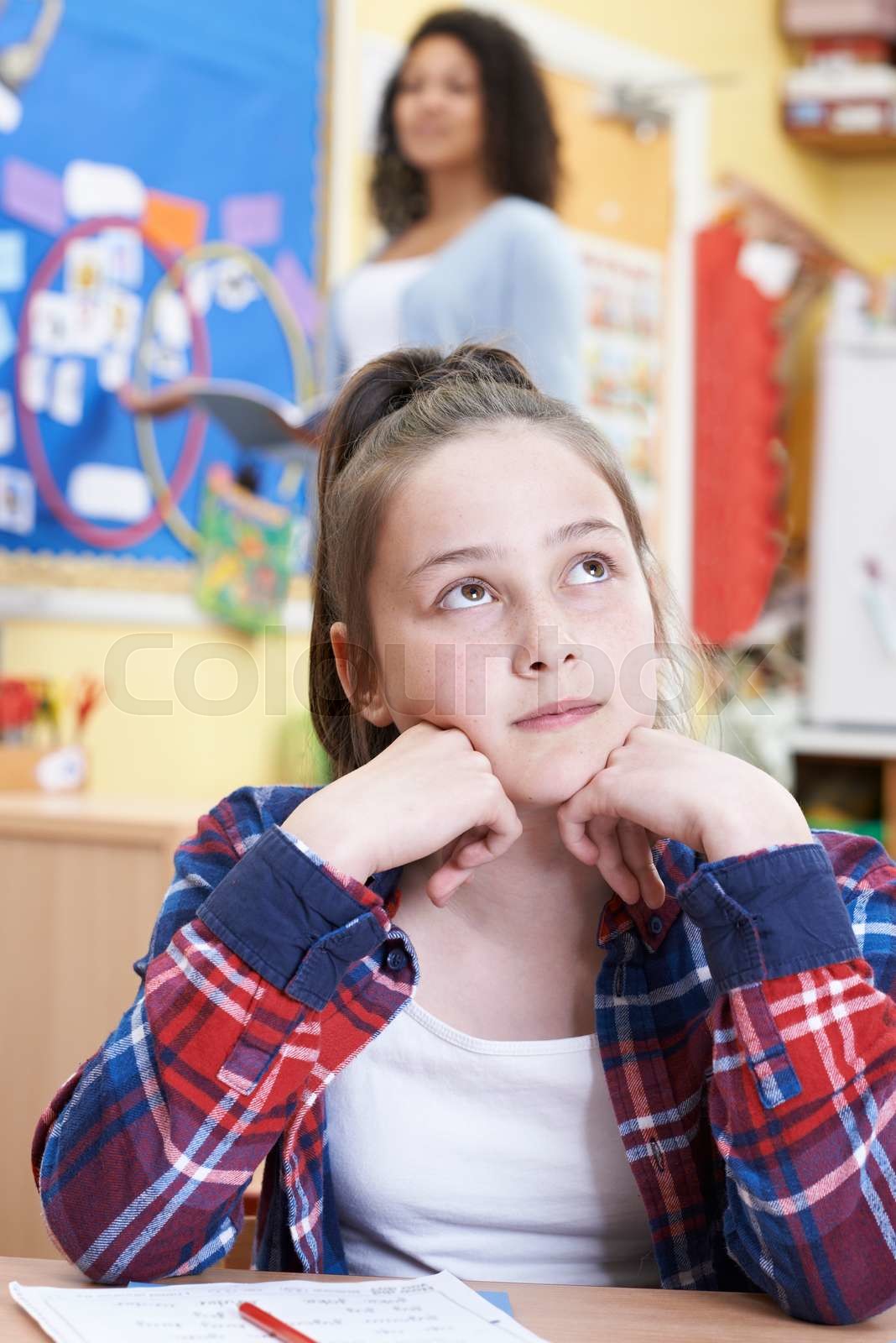 Female Elementary School Pupil Daydreaming In Class | Stock image ...