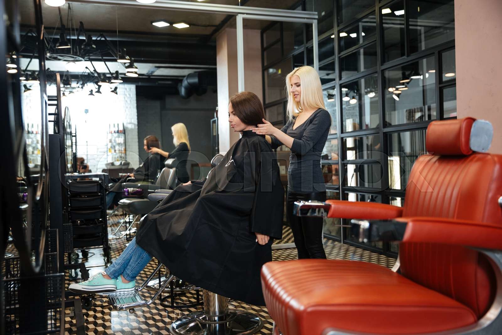 Young girl talking with hairdresser in beauty salon | Stock image ...