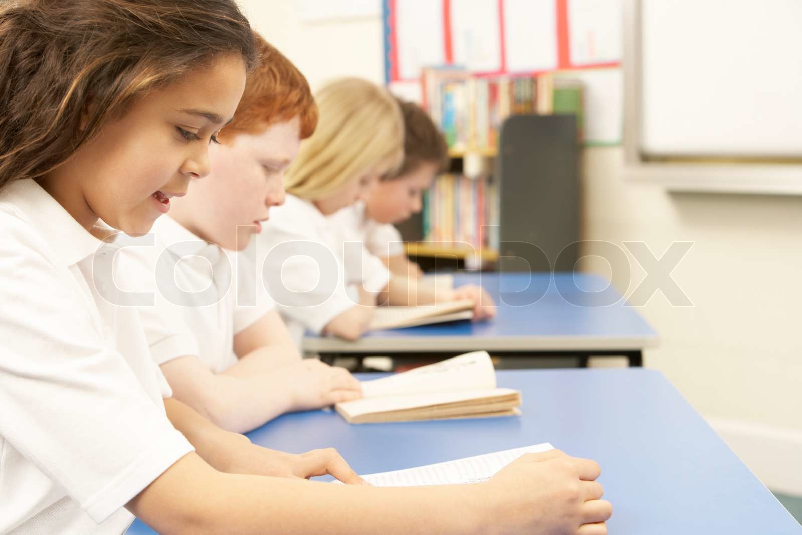 Group Of Children Reading Books In Classroom | Stock image | Colourbox