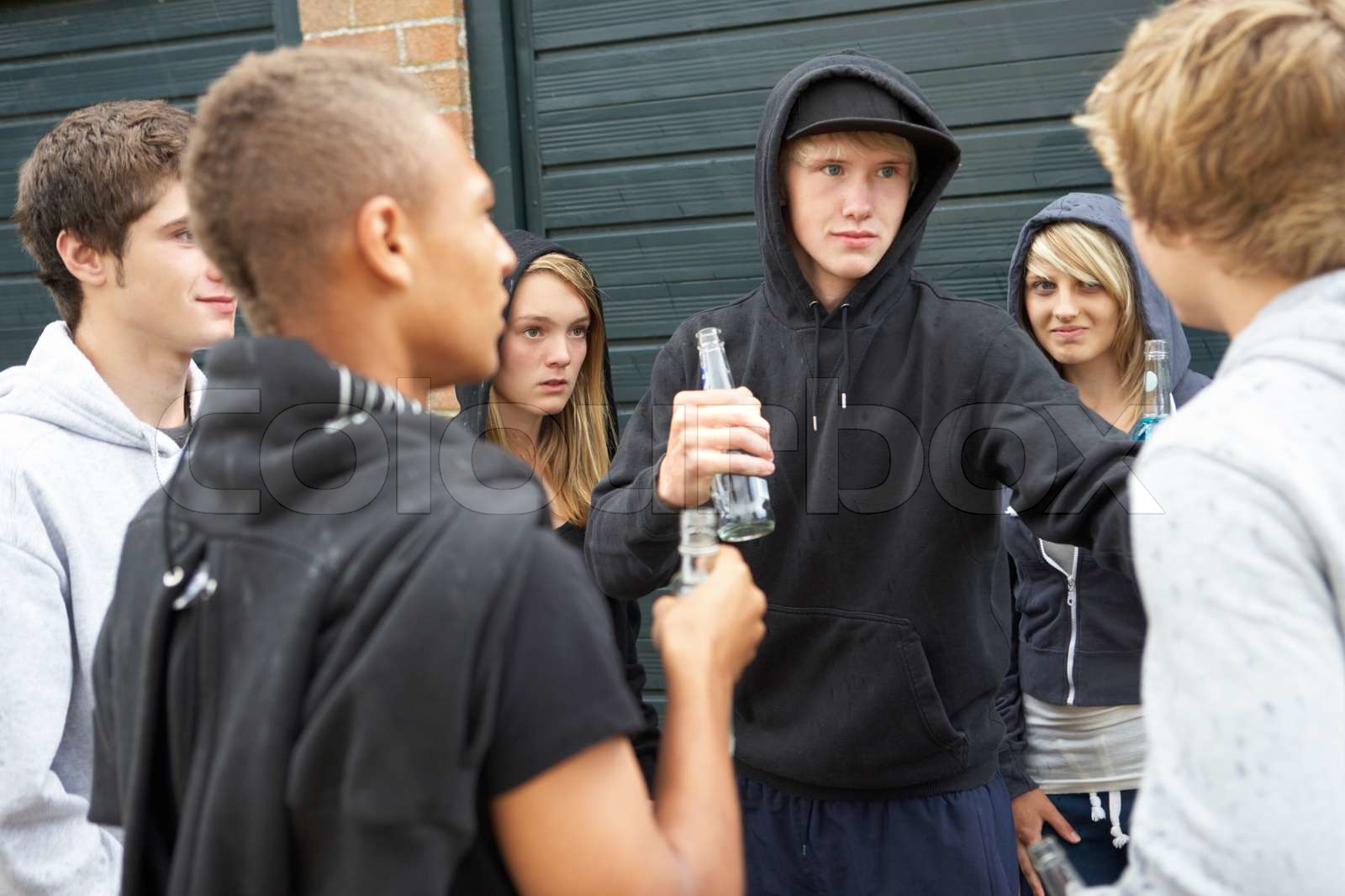 Group Of Threatening Teenagers Hanging Out Together Outside Drinking ...