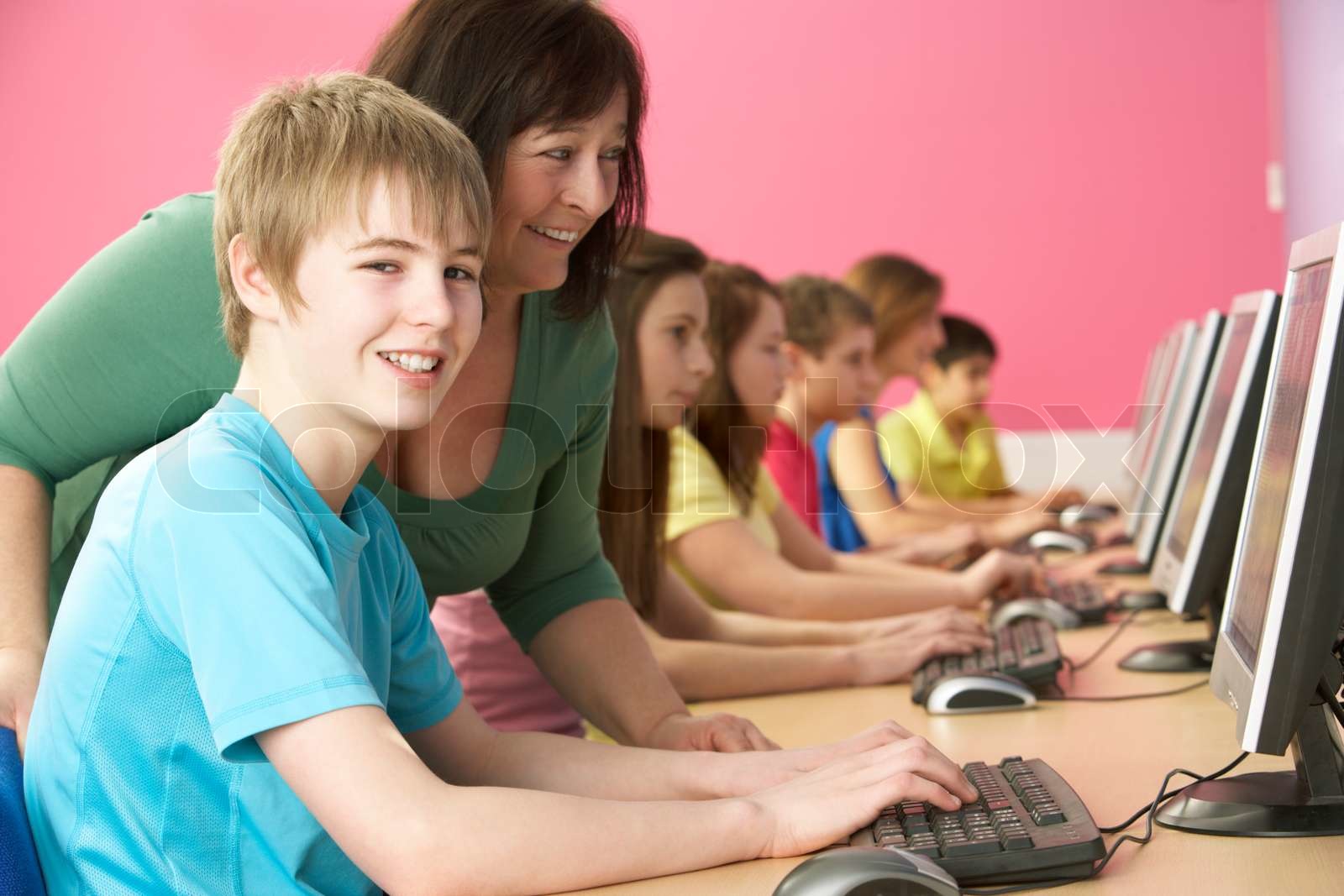 Teenage Students In IT Class Using Computers In Classroom With Tutor ...