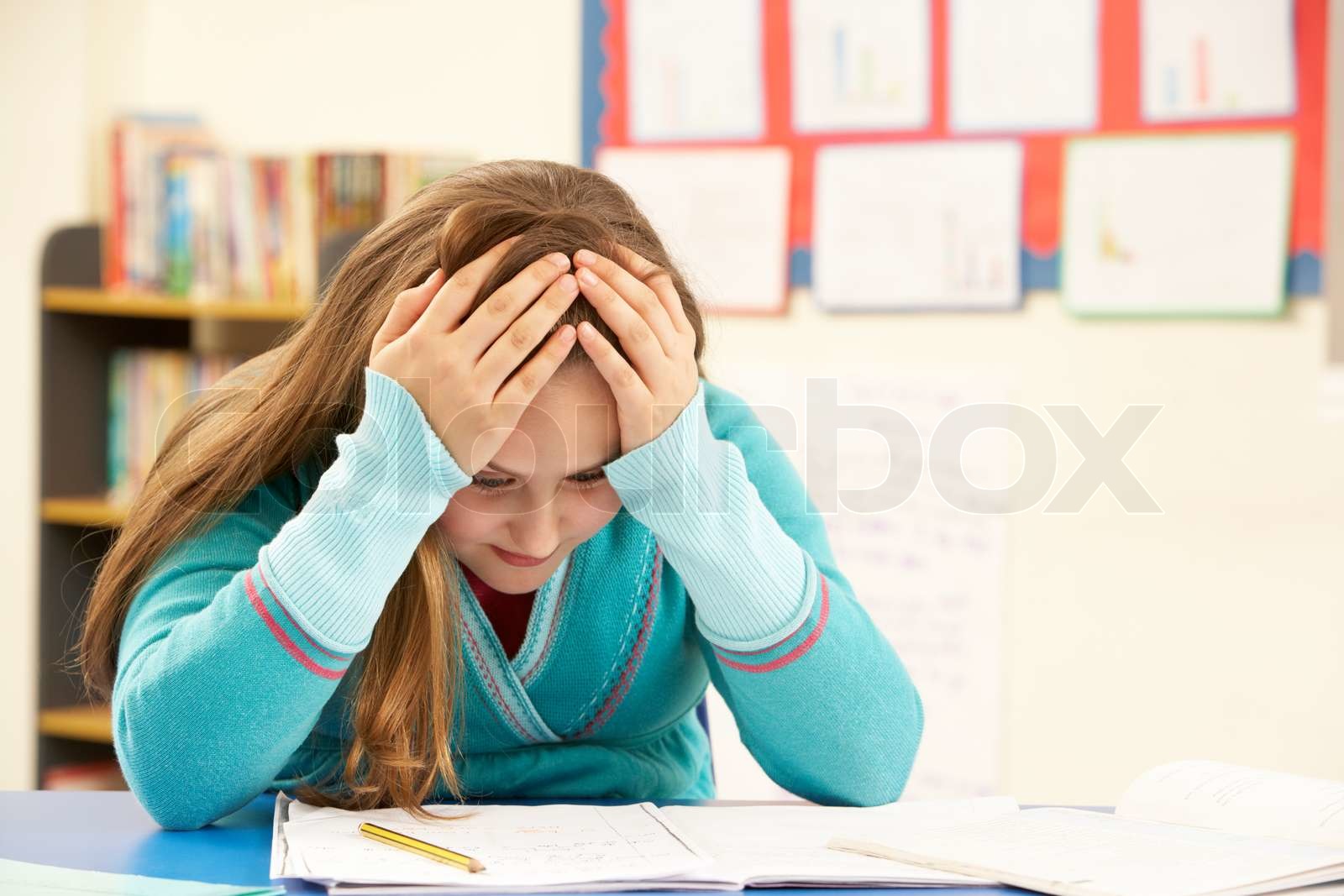 Gestresst Schoolgirl Studying In Classroom | Stock Bild | Colourbox