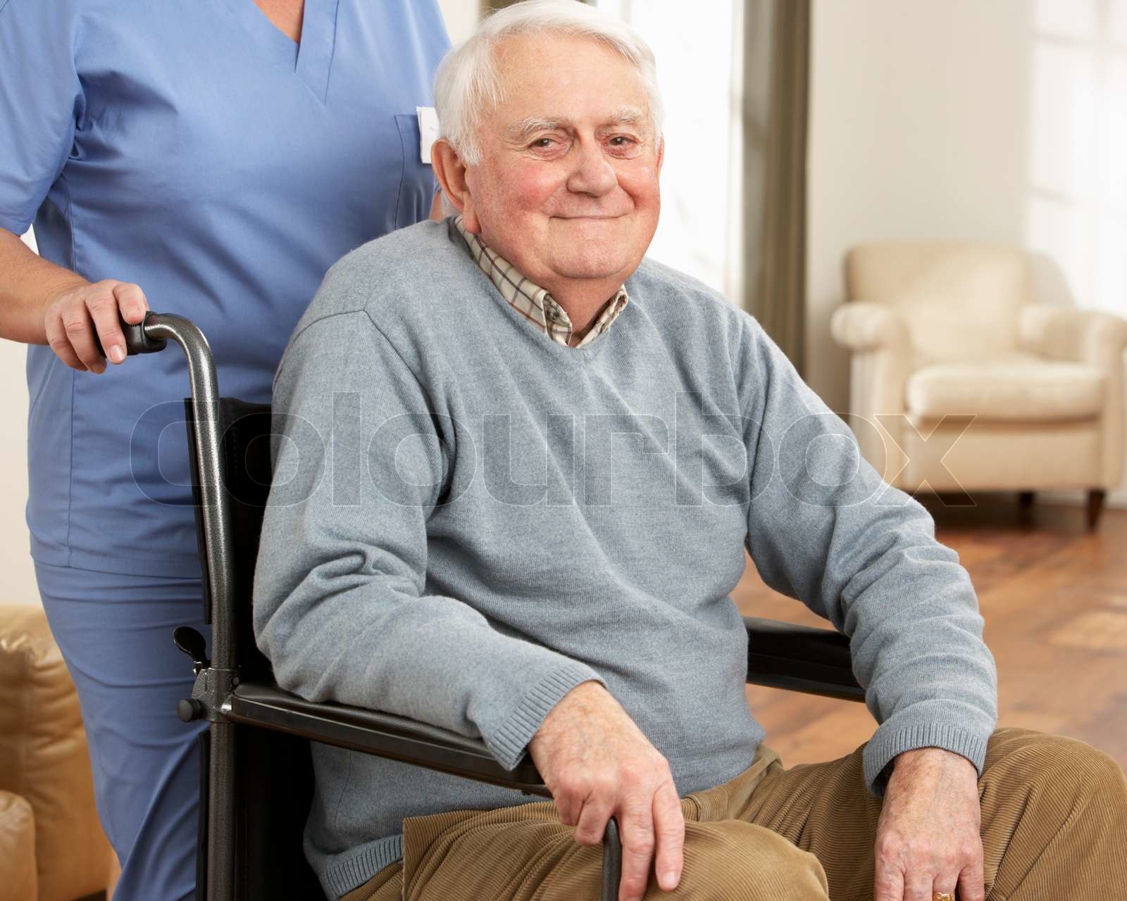 Disabled Senior Man Sitting In Wheelchair With Carer Behind | Stock ...