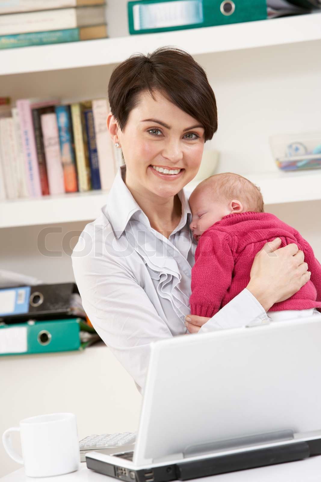 Woman With Newborn Baby Working From Home Using Laptop | Stock image ...