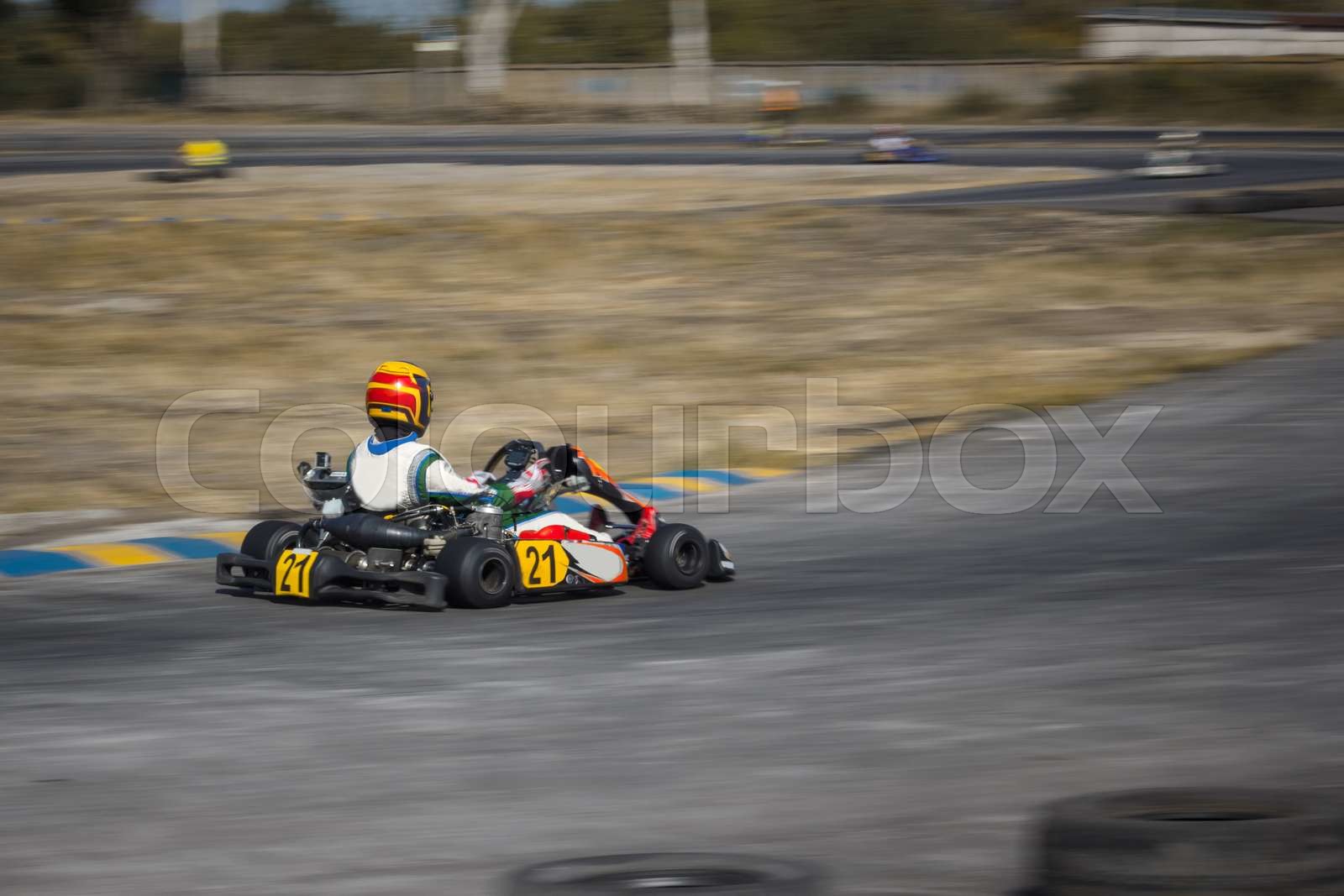 Karting - driver in helmet on kart circuit | Stock image | Colourbox