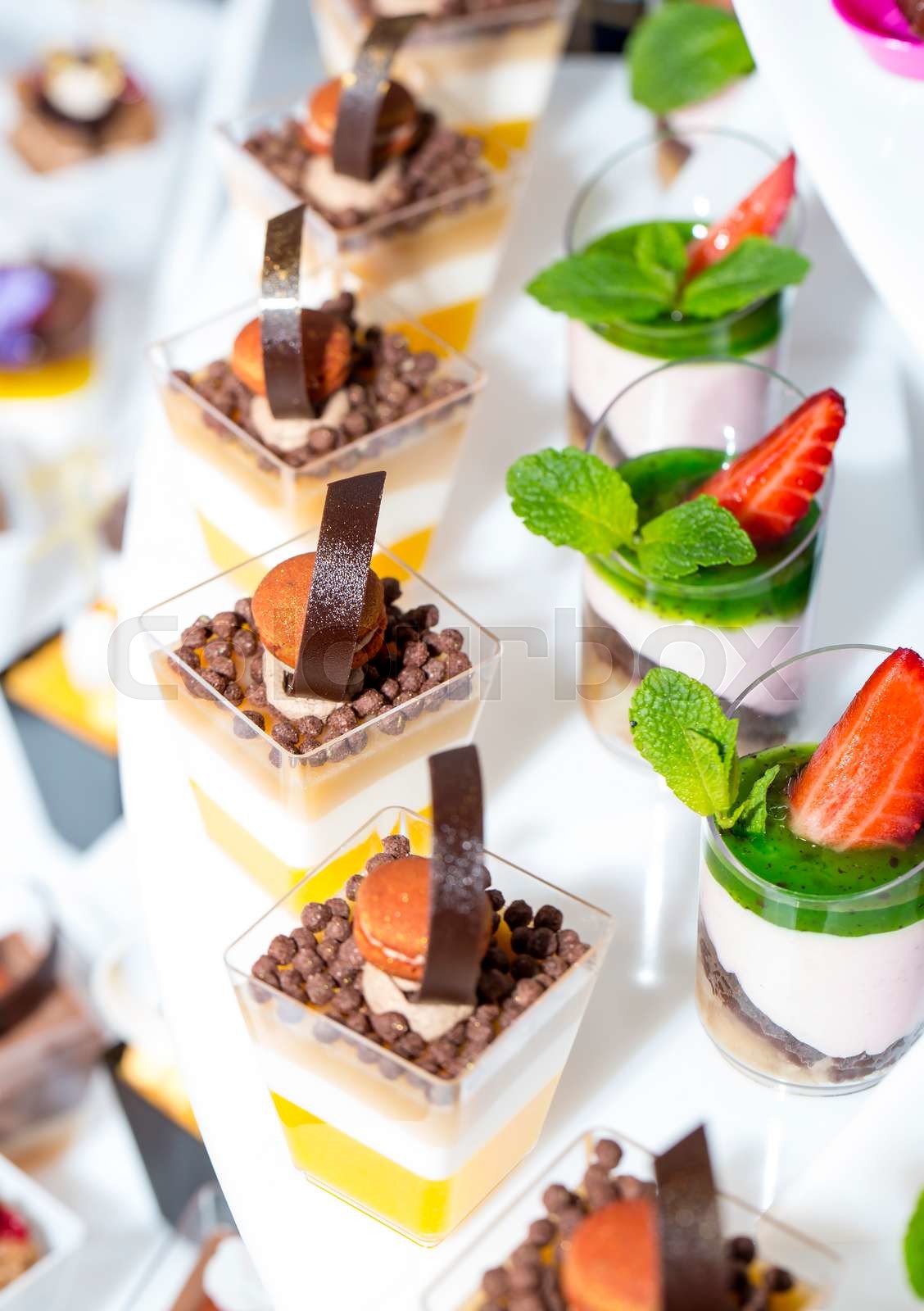 mini canapes in plastic cups decorated with edible flowers | Stock ...